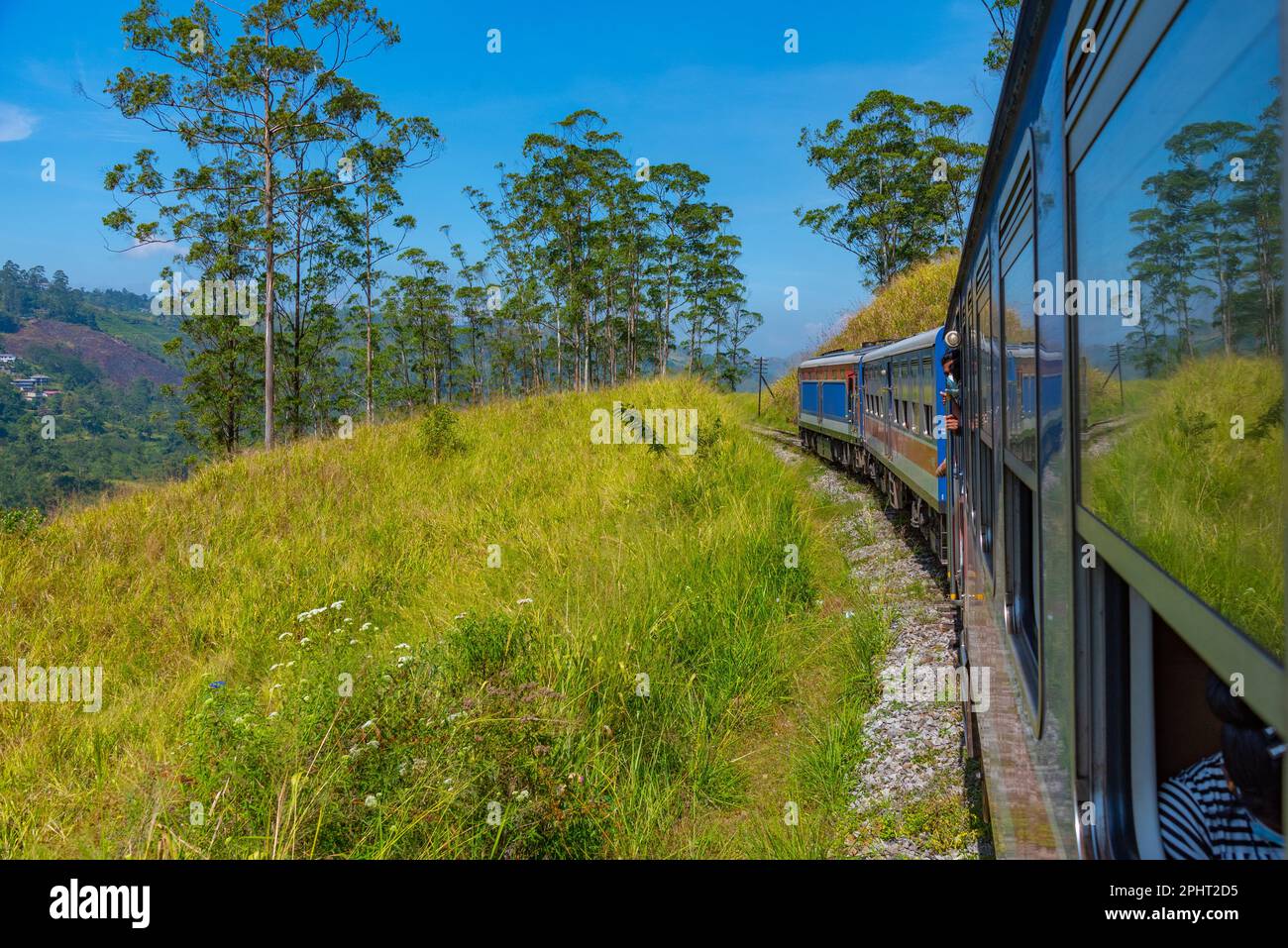 Train winding on a hillside track among tea plantations at Sri Lanka ...