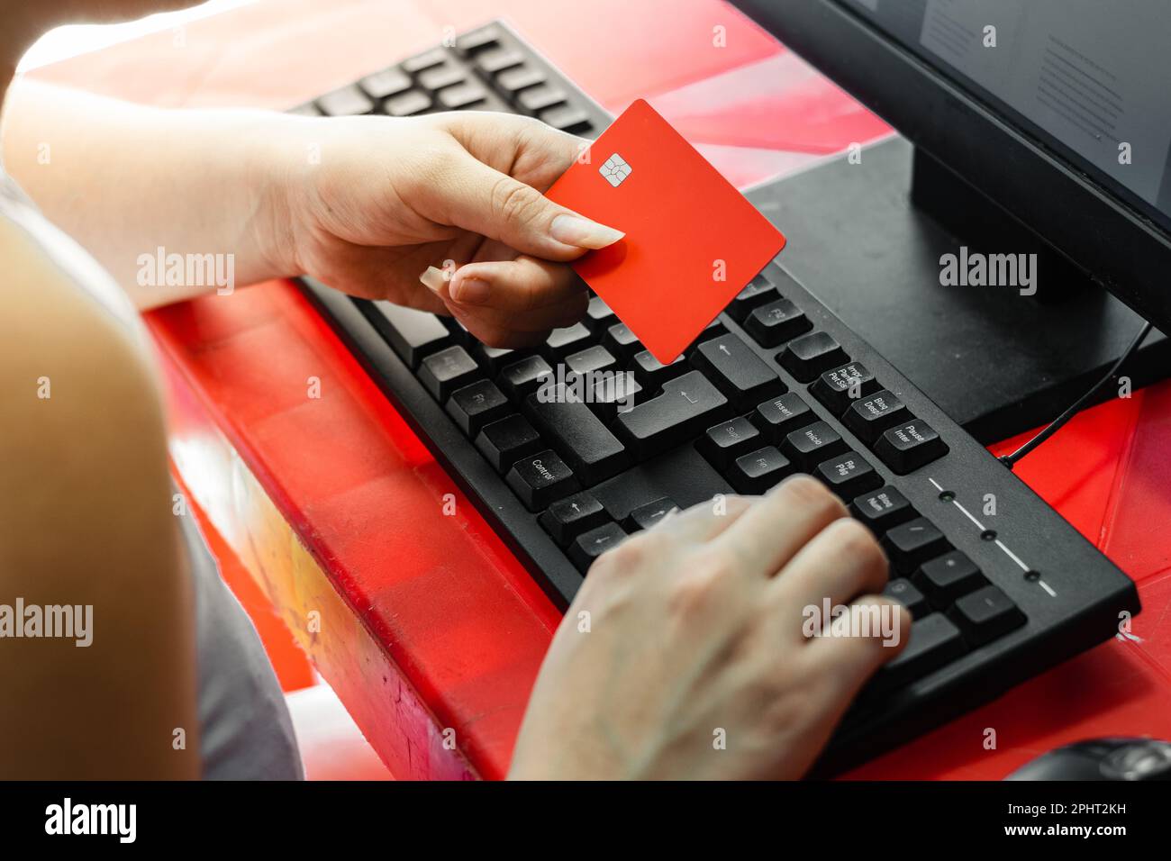 young latina woman with card in hand while typing the password on the ...