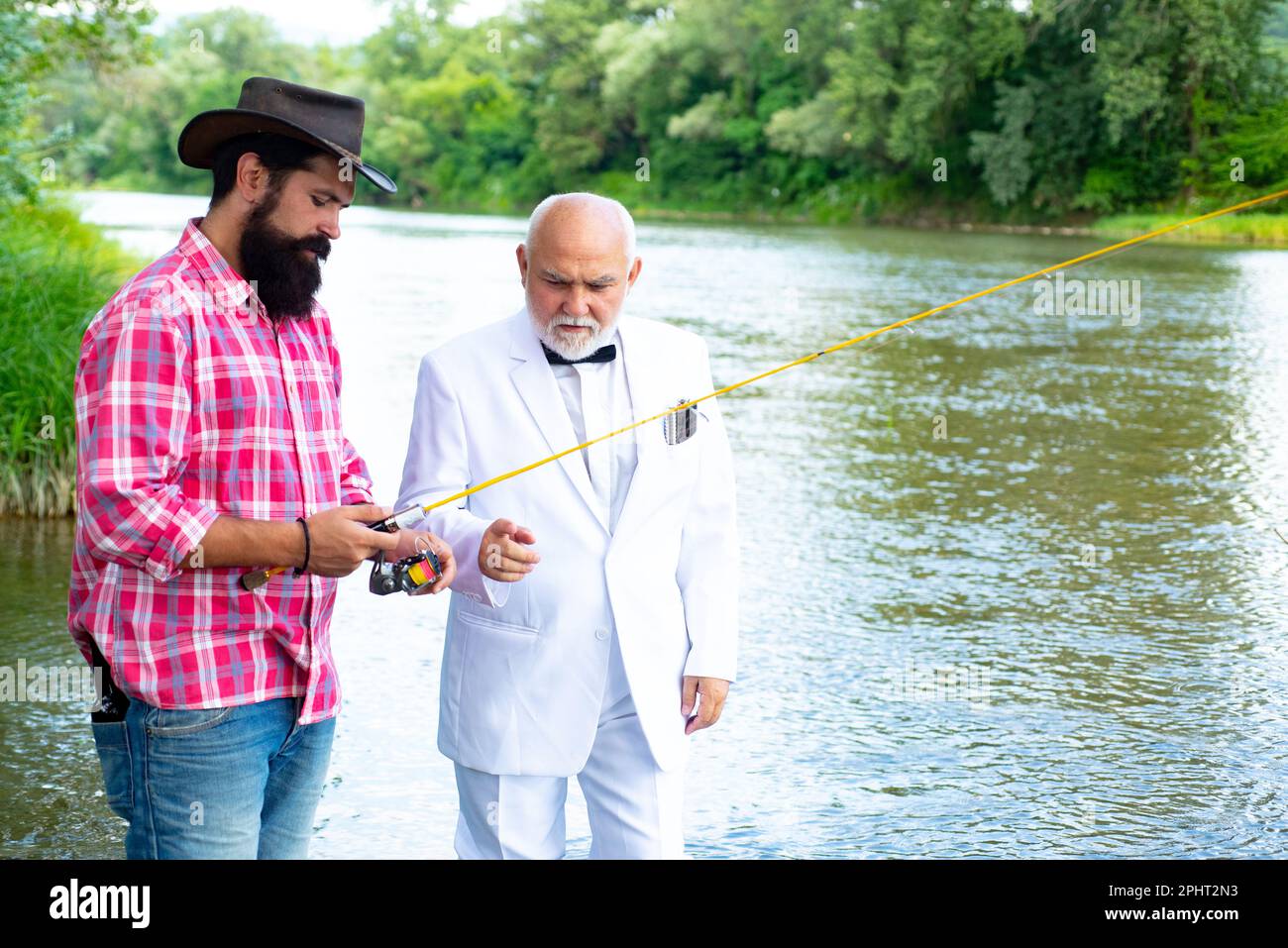 Two men friends fishing. Flyfishing angler makes cast, standing in ...