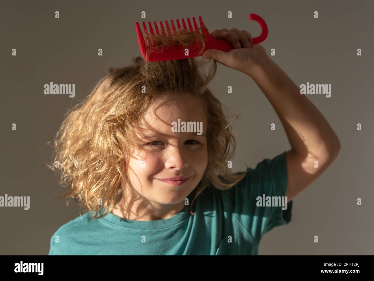 Kids hair. Closeup portrait of little child brushing hair. Little child ...