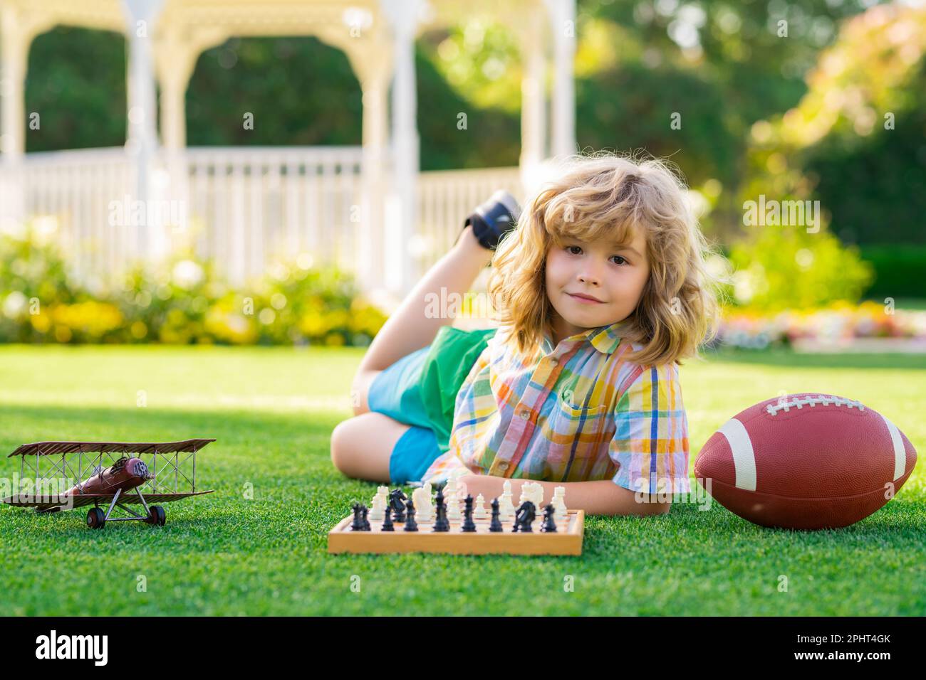 Dream kids and childhood concept. Kid laying on grass enjoy summer ...