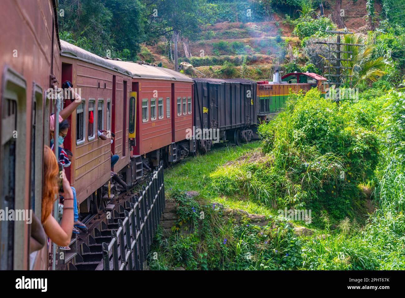Train winding on a hillside track among tea plantations at Sri Lanka ...