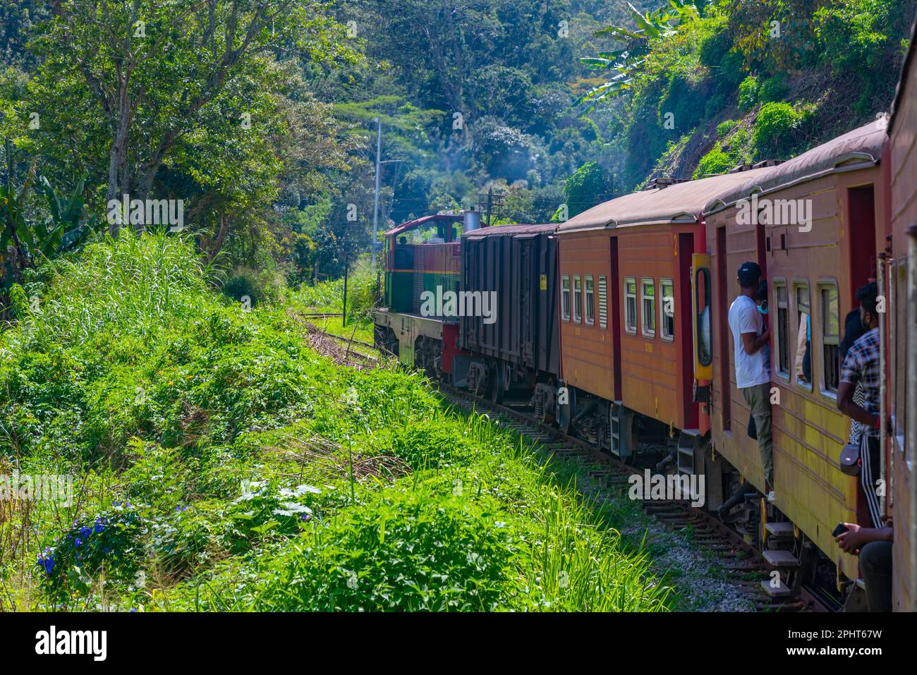 Train winding on a hillside track among tea plantations at Sri Lanka ...