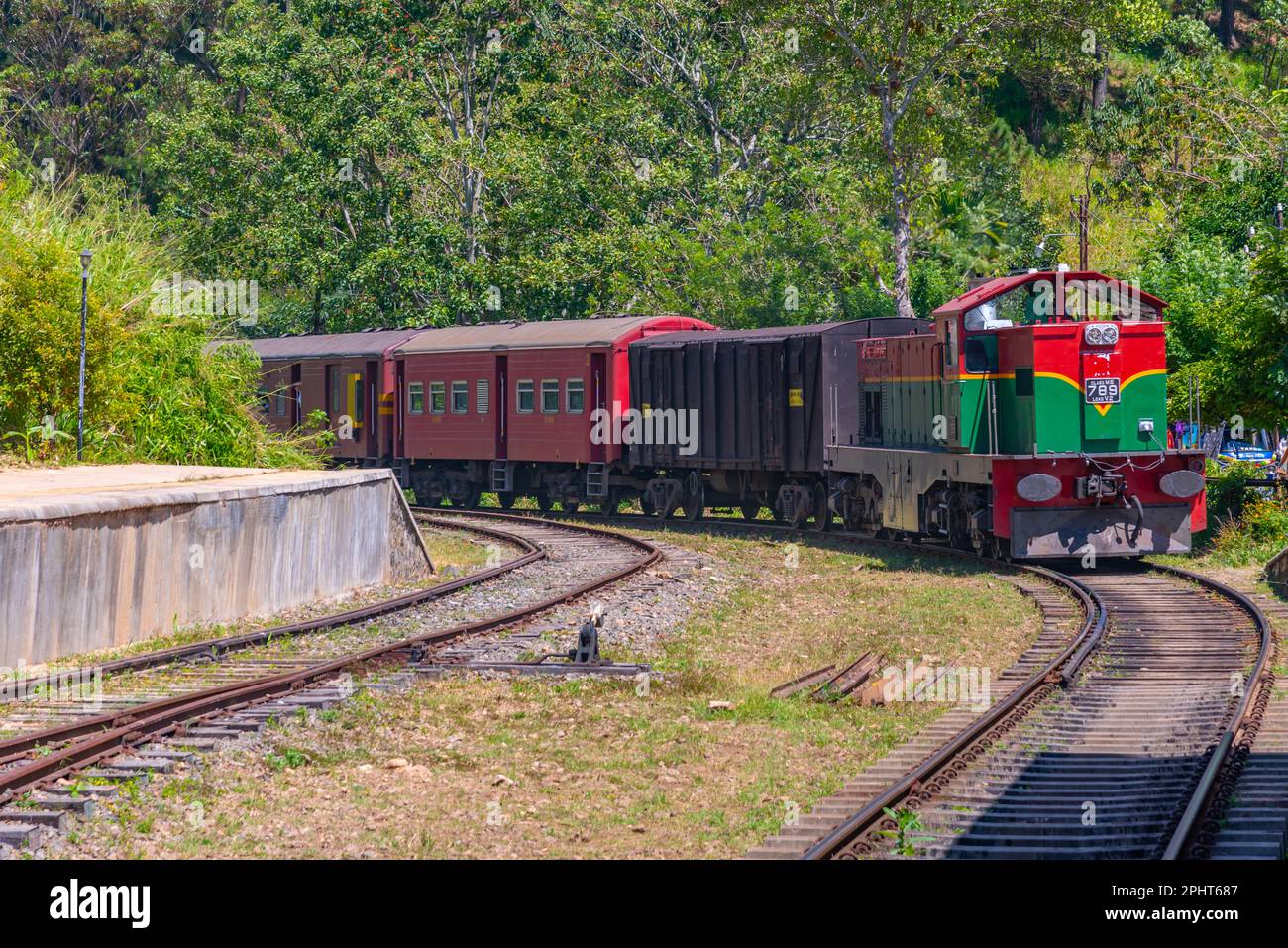 Train winding on a hillside track among tea plantations at Sri Lanka ...