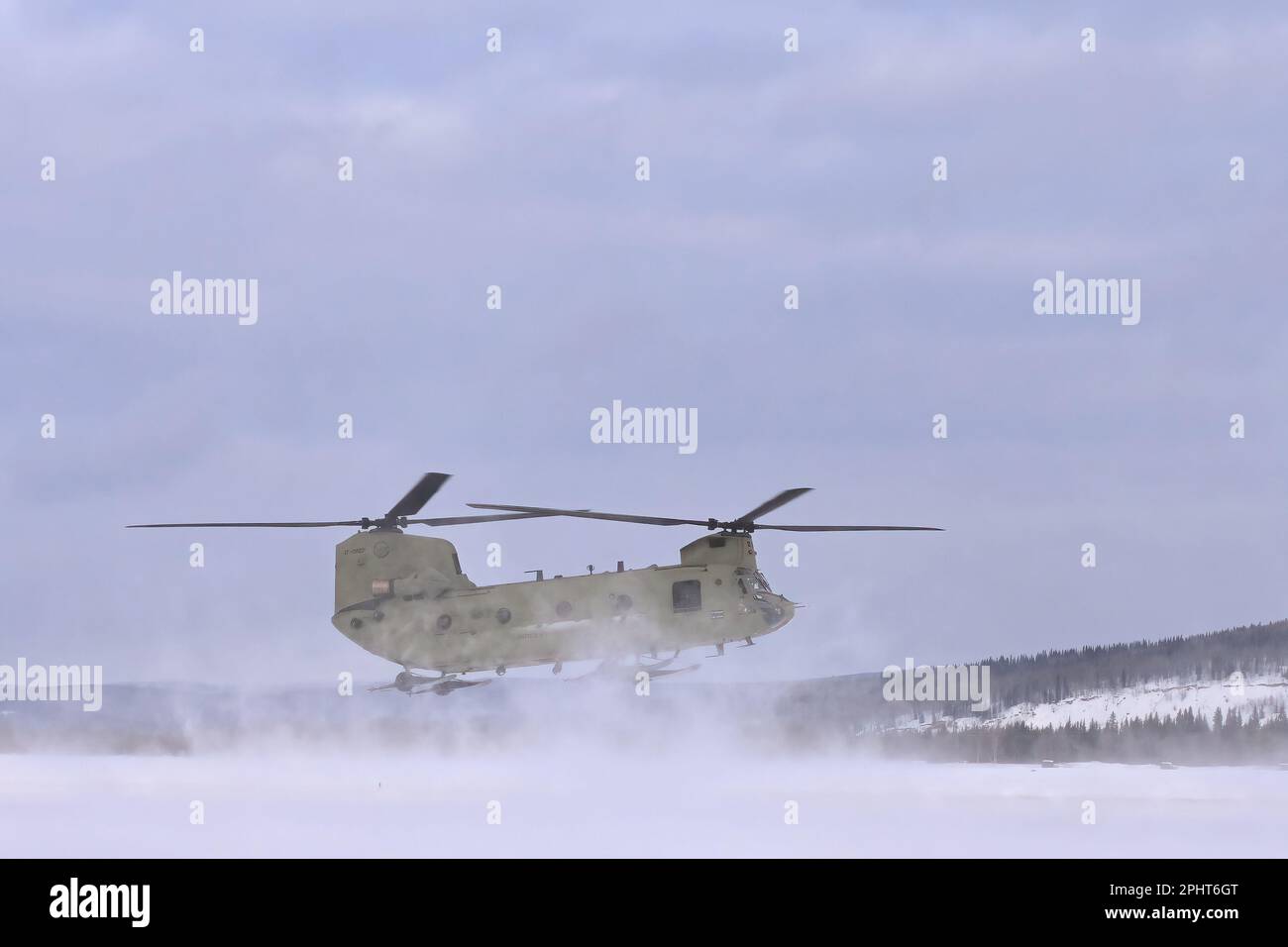 Snow billows as a CH-47 Chinook helicopter from B Company, 1st ...