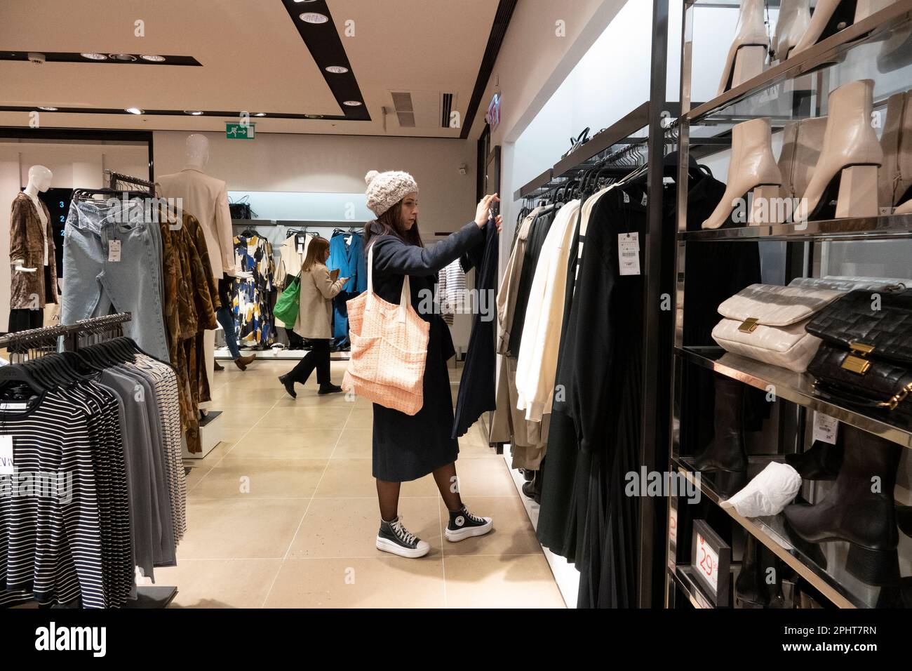 Girl looking at clothes in a store Stock Photo - Alamy