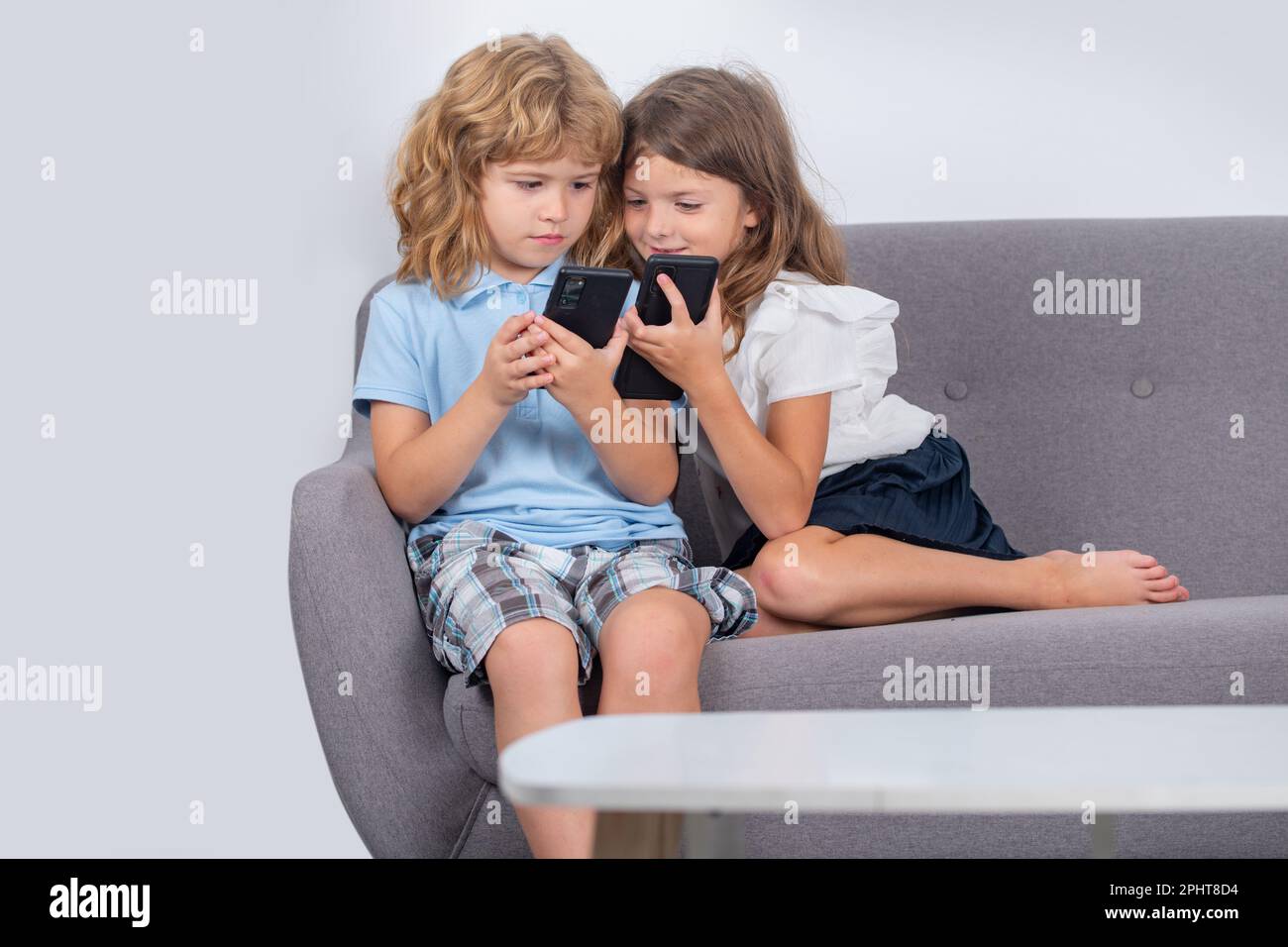 Two kids alone with phone at home. Children friends and friendship ...