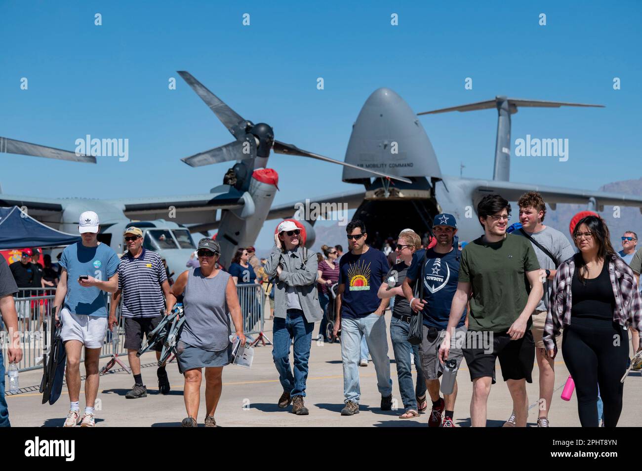 Air show attendees wander the flight line filled with static display ...