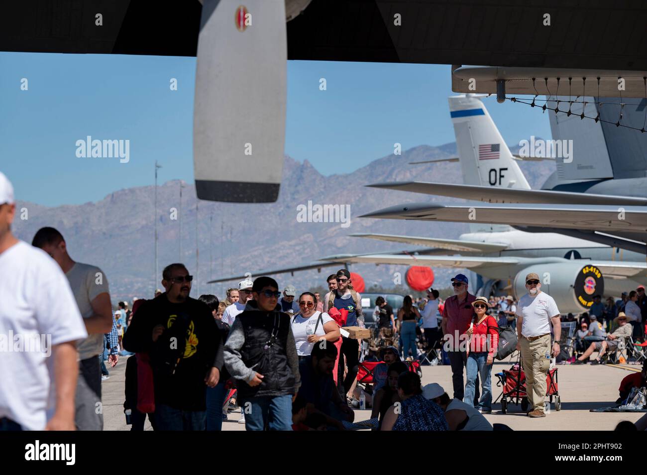 Air show attendees wander the flight line filled with static display ...