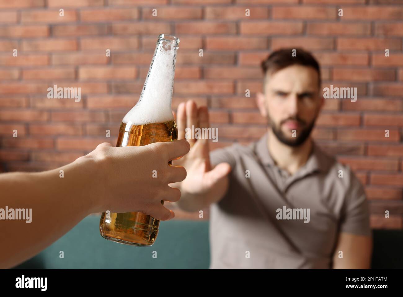 Man refusing to drink beer indoors, closeup. Alcohol addiction ...