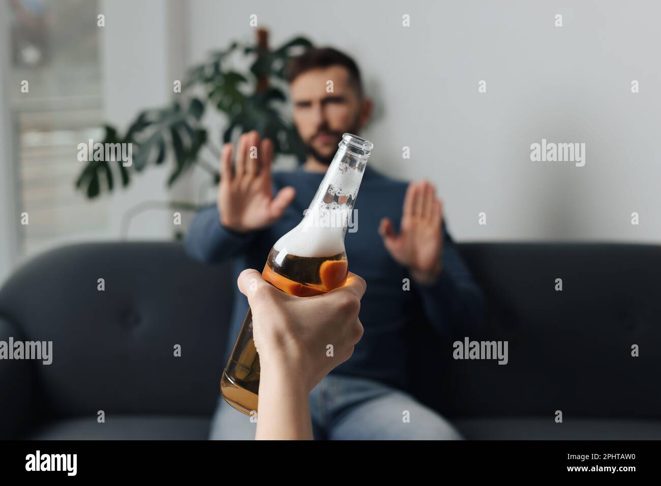 Man refusing to drink beer indoors, closeup. Alcohol addiction ...