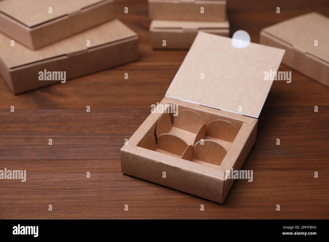 Empty packaging box with dividers on wooden table. Production line ...