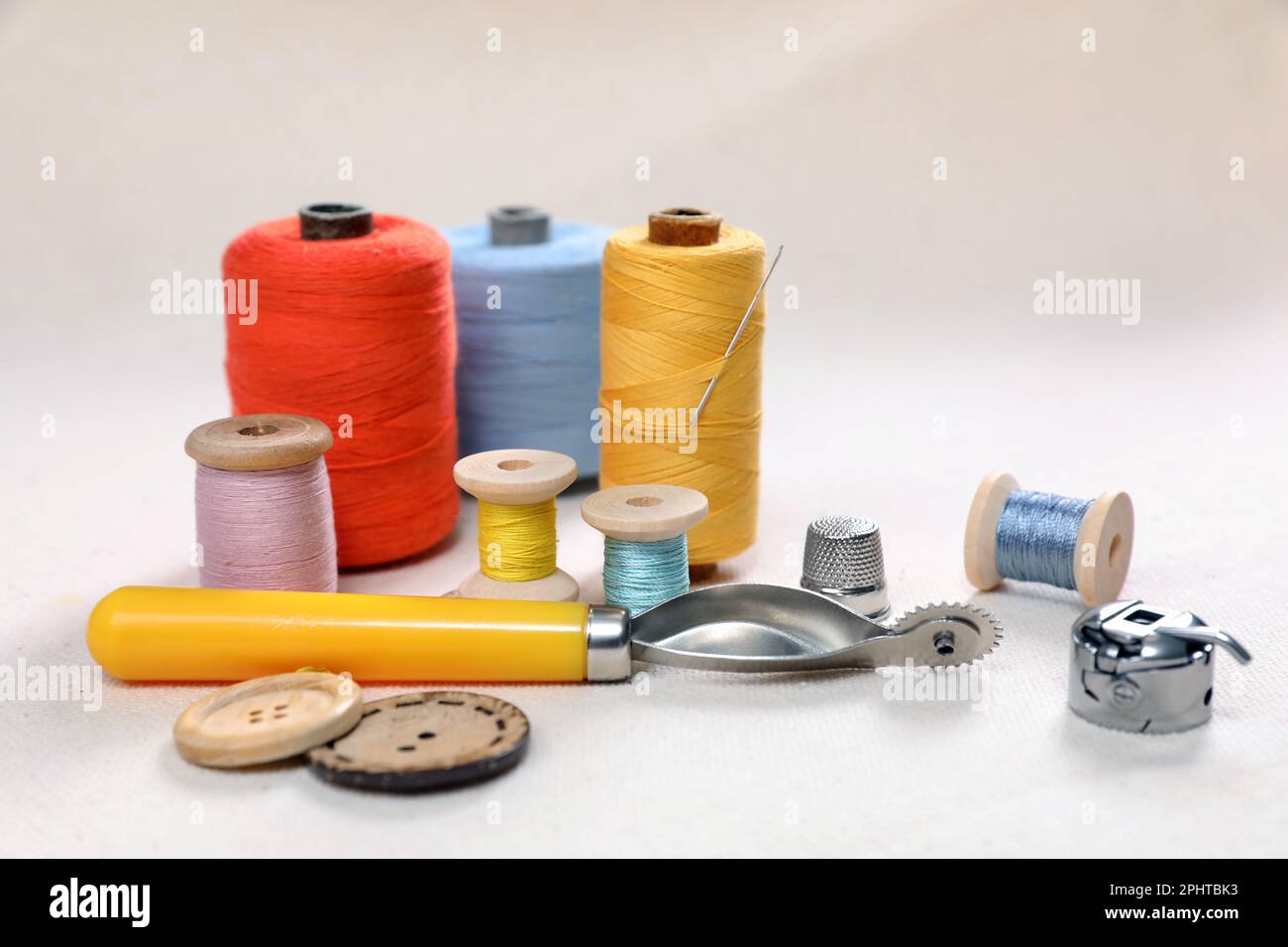 Color threads, tracing wheel and other sewing accessories on white ...