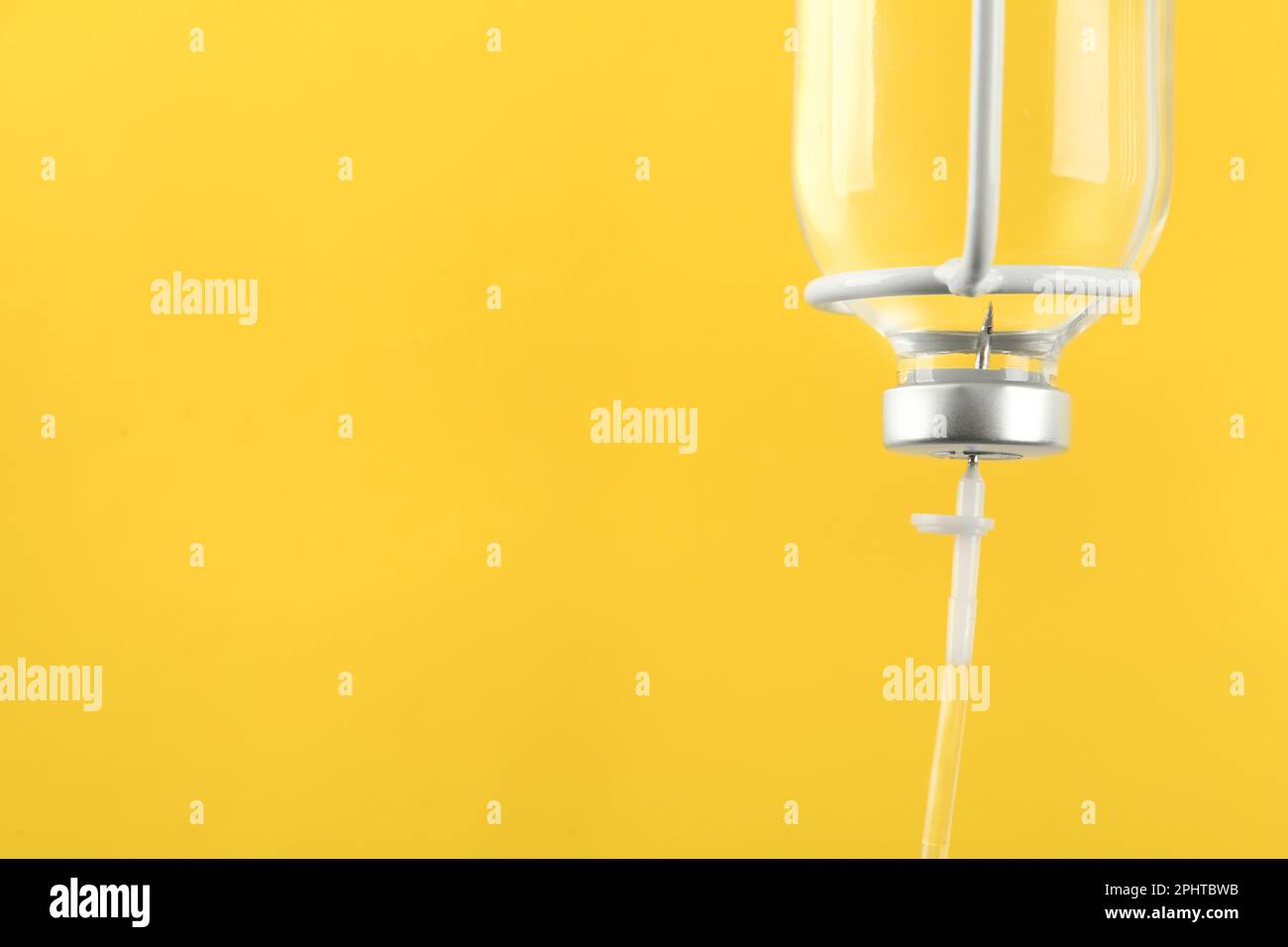 IV infusion set on yellow background, closeup. Space for text Stock ...
