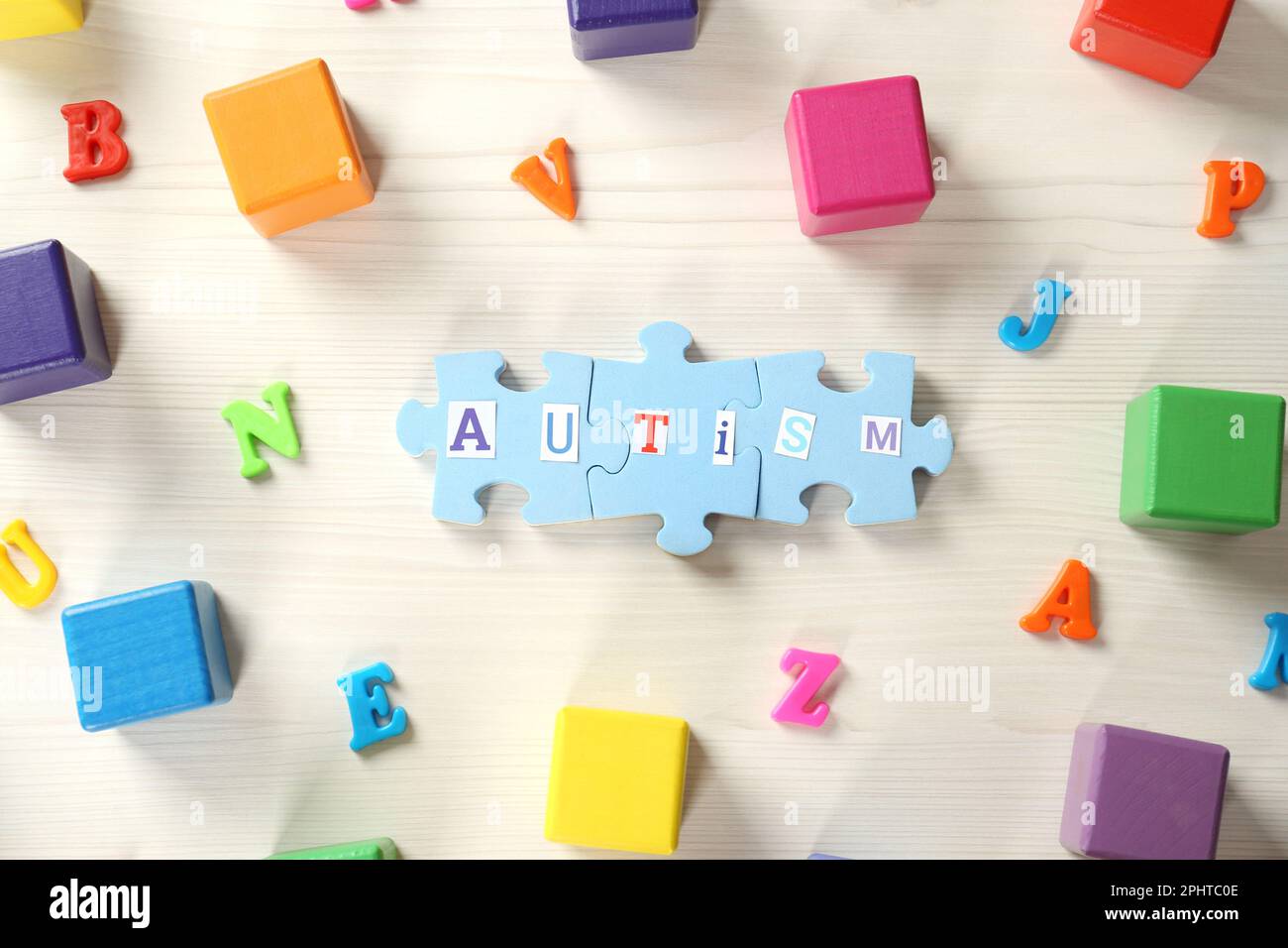 Word Autism made of puzzle pieces, colorful cubes and letters on white ...