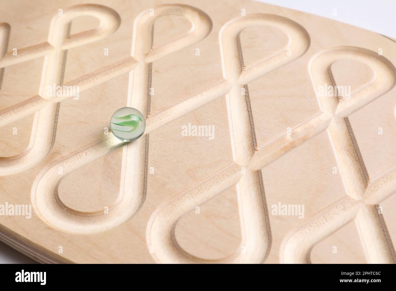 Wooden labyrinth balance board on white background, closeup. Montessori ...