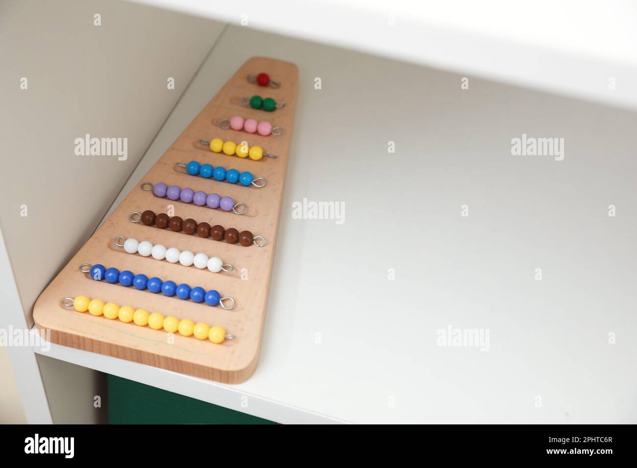 Wooden board with color bead lines on shelf, space for text. Montessori ...
