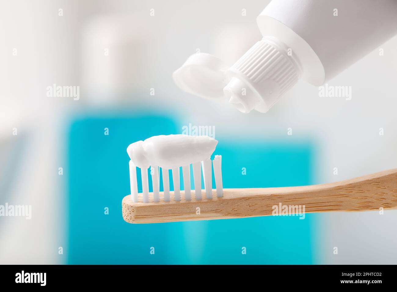 Applying toothpaste on brush against blurred background, closeup Stock ...