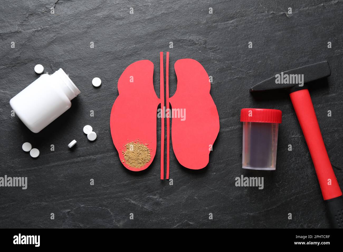 Flat lay composition of kidneys paper cutout with sand on black ...