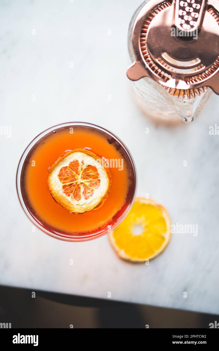 Boulevardier cocktail with orange wheel on marble background with ...