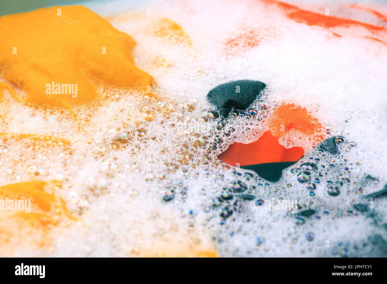 Colorful clothes in suds, closeup. Hand washing laundry Stock Photo - Alamy