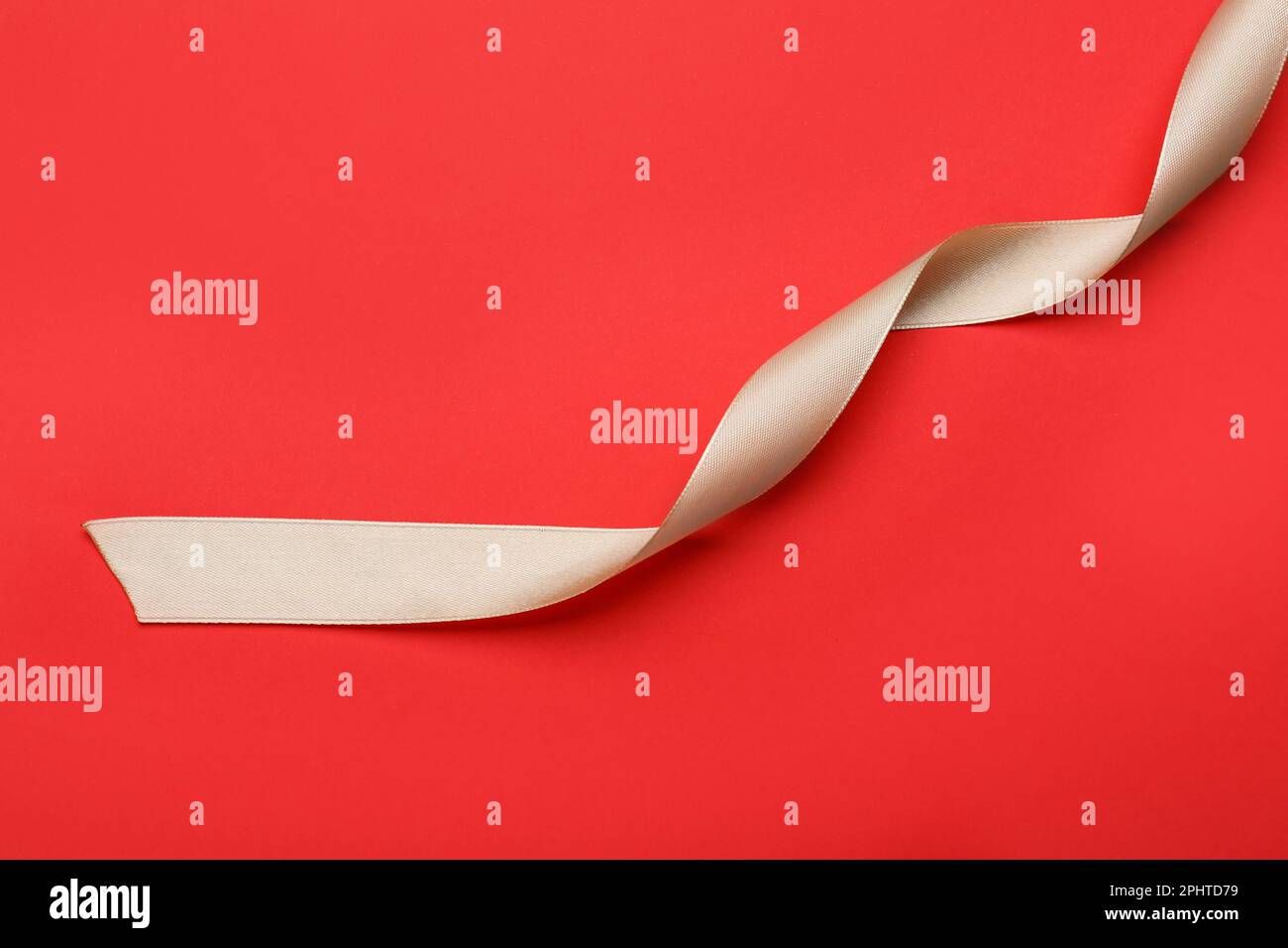 Beautiful ribbon on red background, top view Stock Photo - Alamy