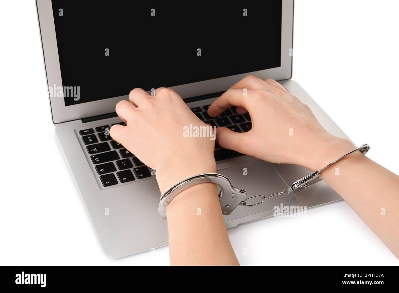 Woman in handcuffs typing on laptop against white background, closeup ...