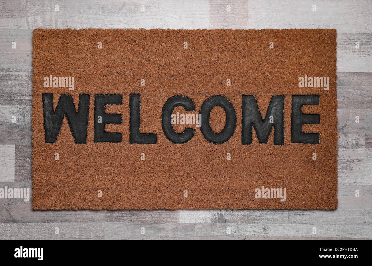 New clean mat with word WELCOME on floor, top view Stock Photo - Alamy
