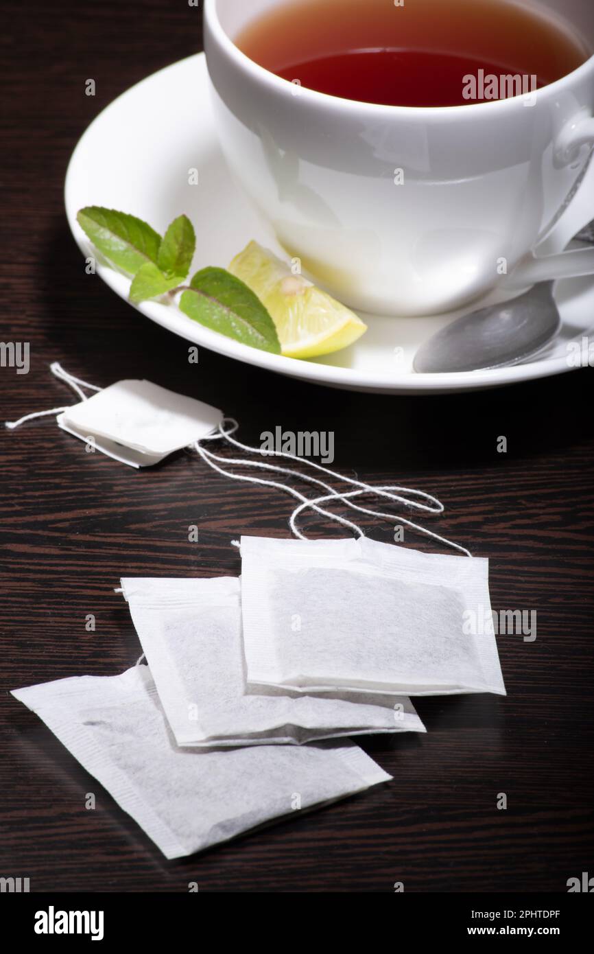 Teabags with cup of lemon tea, healthy drink Stock Photo - Alamy