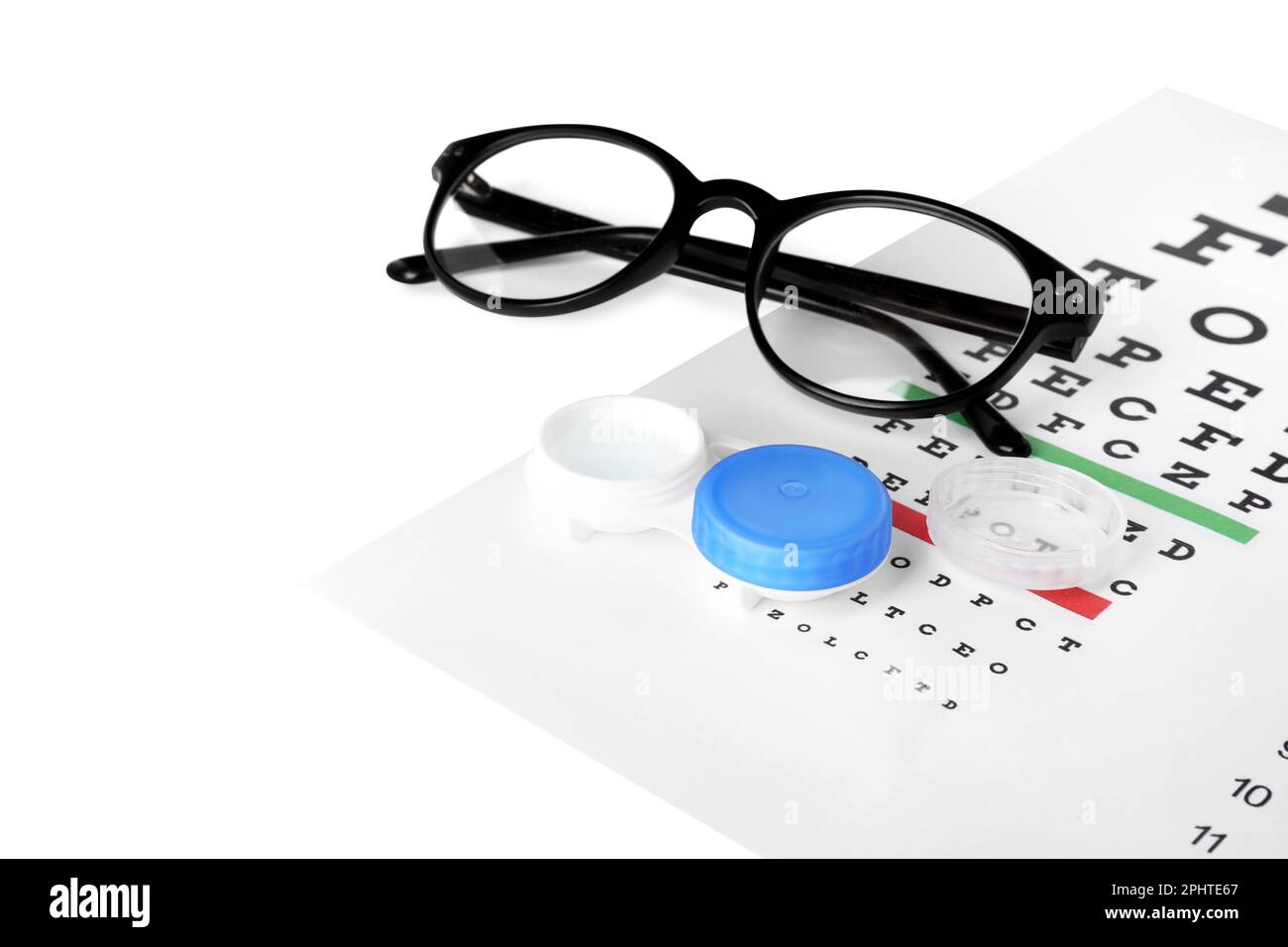 Case with contact lenses, glasses and eye chart test on white ...