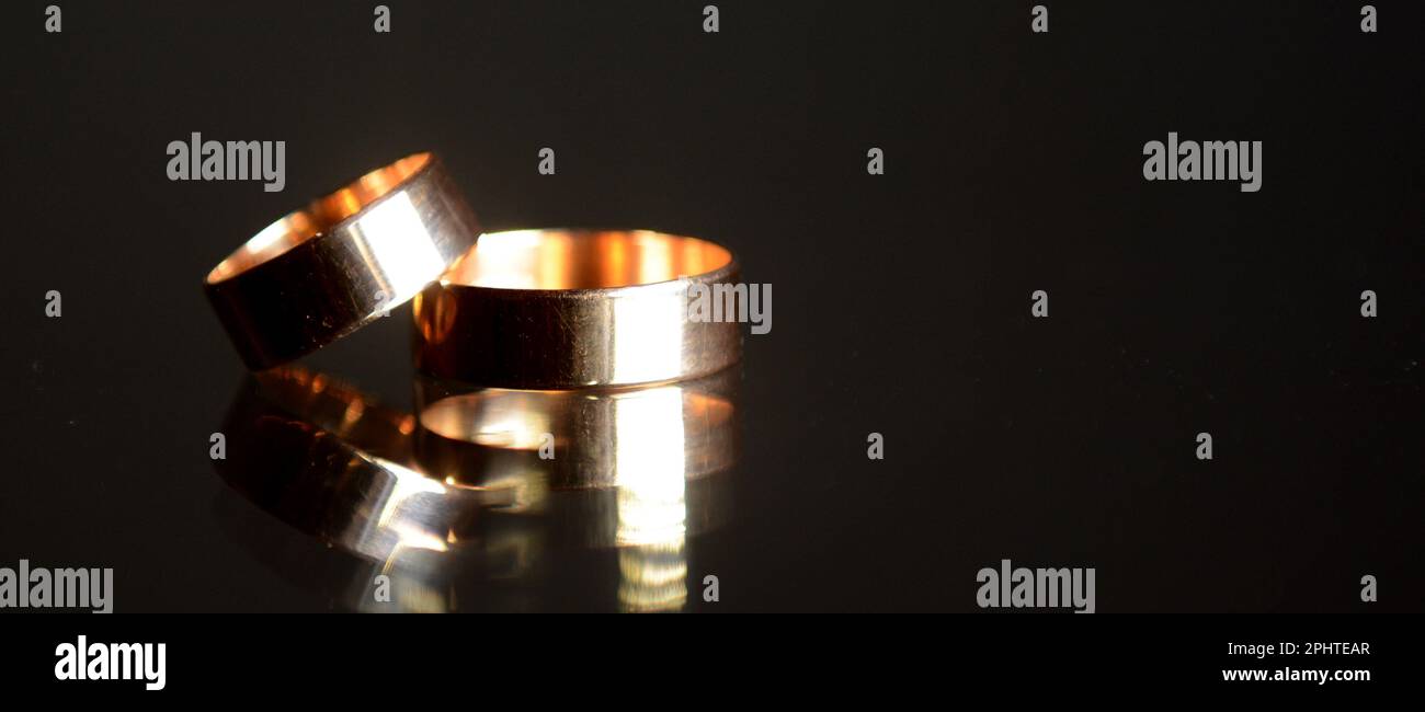 wedding gold rings on a black background. High quality photo Stock ...