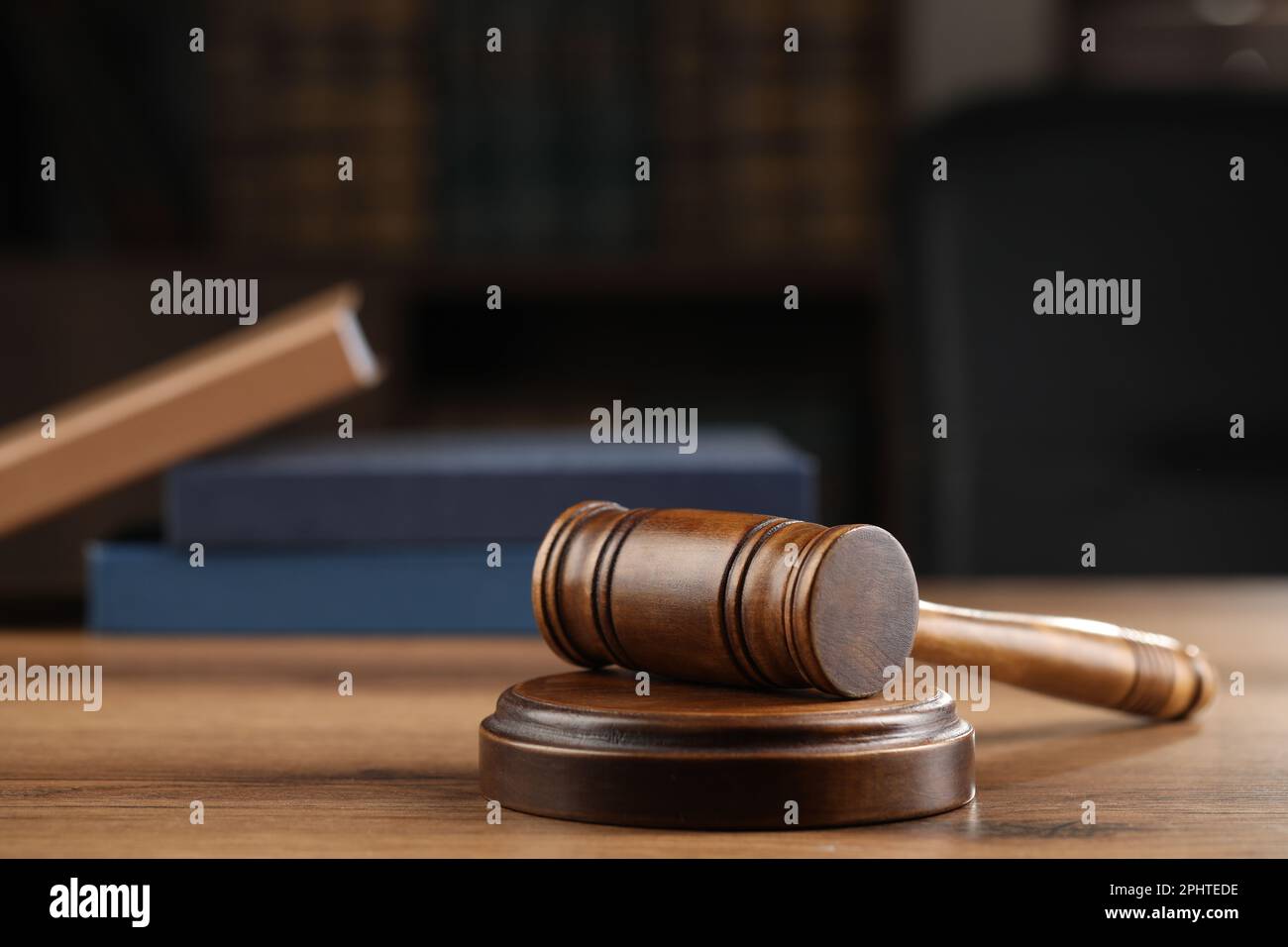 Wooden gavel on table against blurred background Stock Photo - Alamy