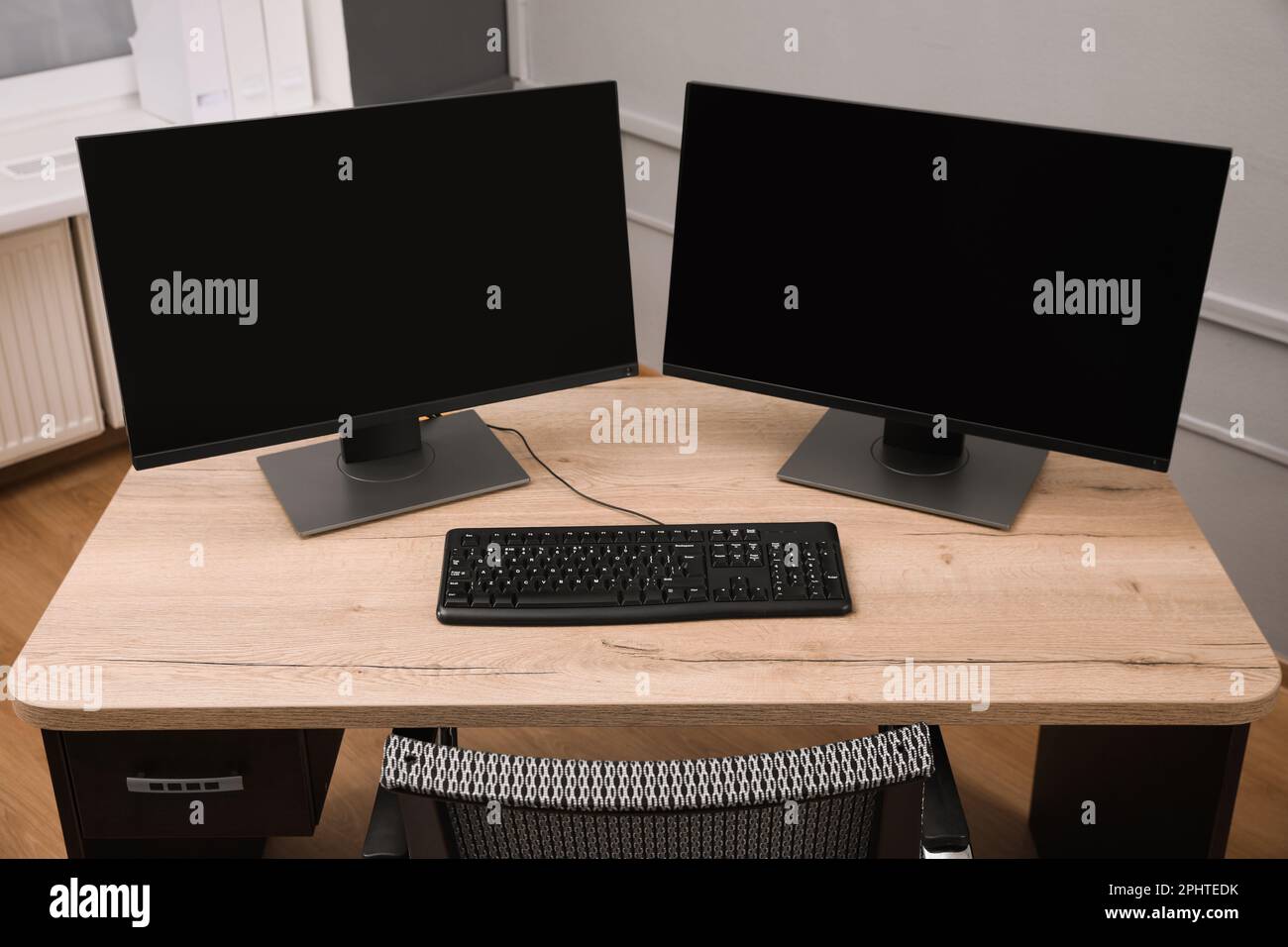 Modern interior. Workplace with multi-monitor on wooden desk in office ...