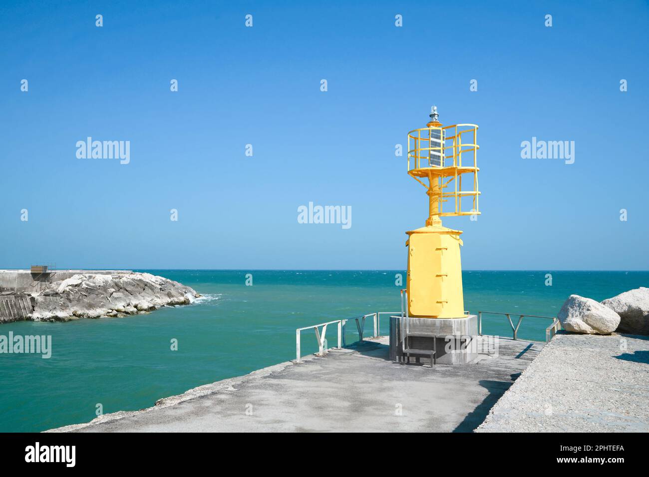 Yellow navigational aid beacon with solar battery on pier Stock Photo ...