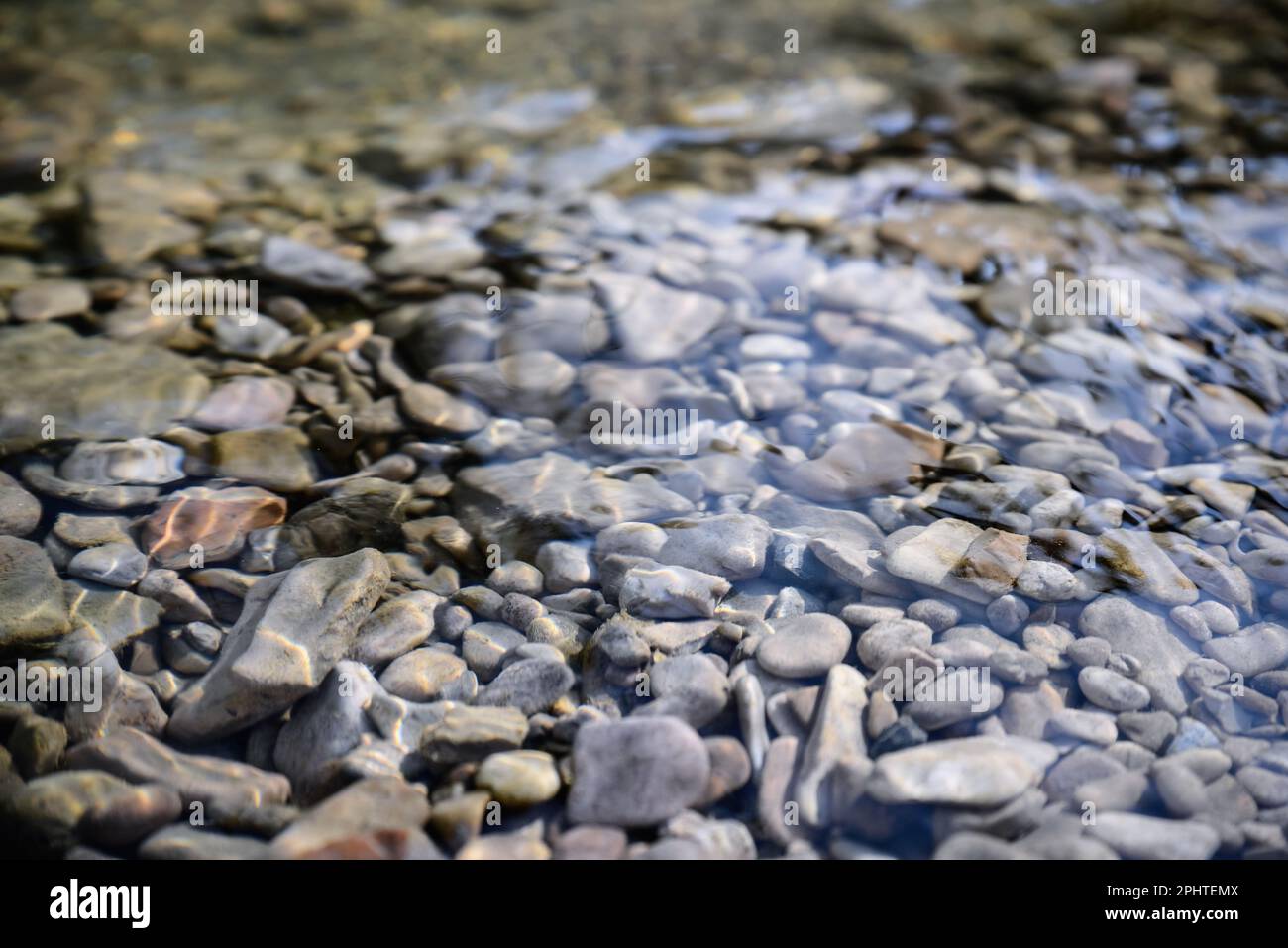 Stones and pebbles on bottom of river Stock Photo - Alamy
