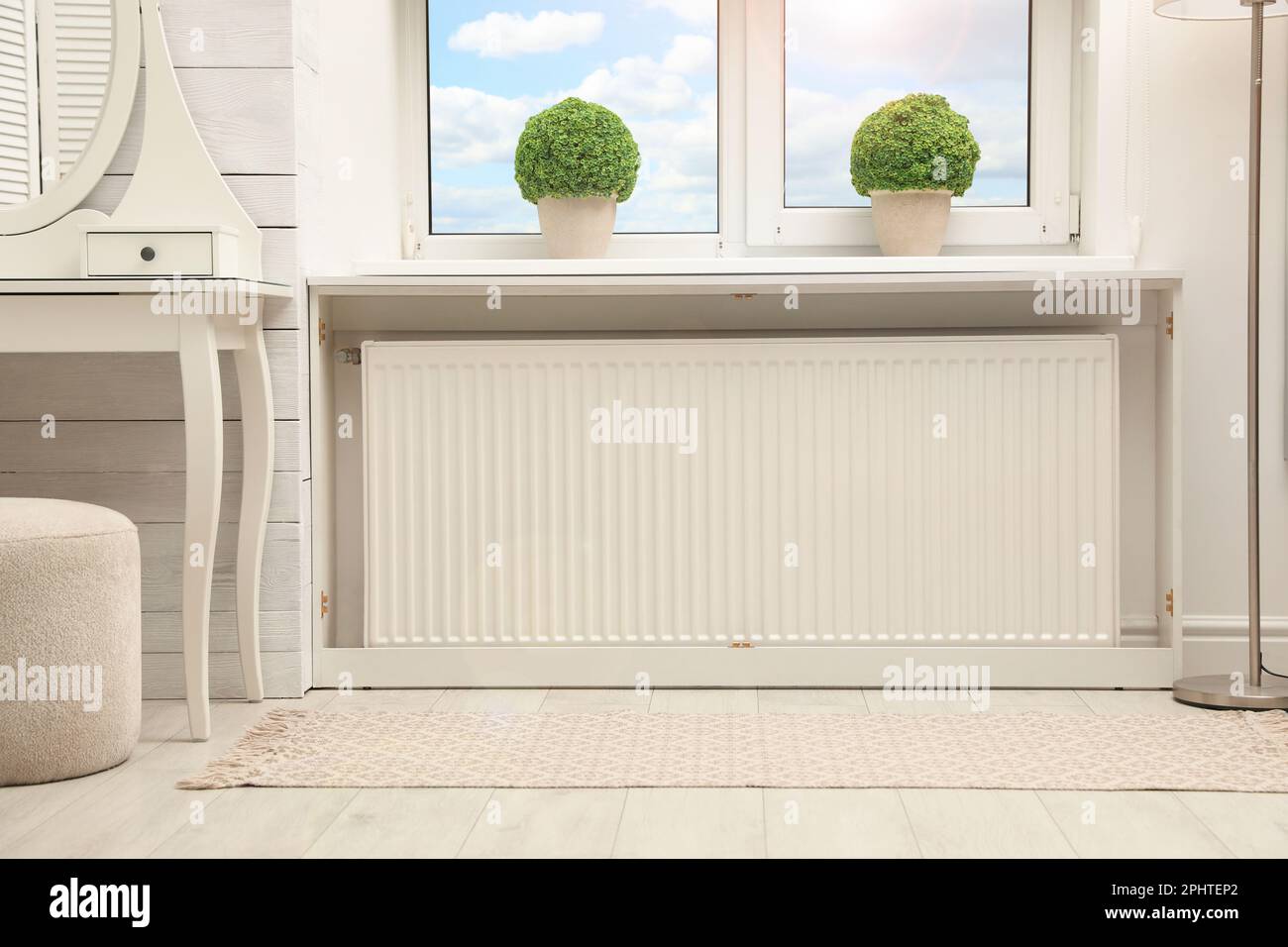 Modern radiator at home. Central heating system Stock Photo - Alamy
