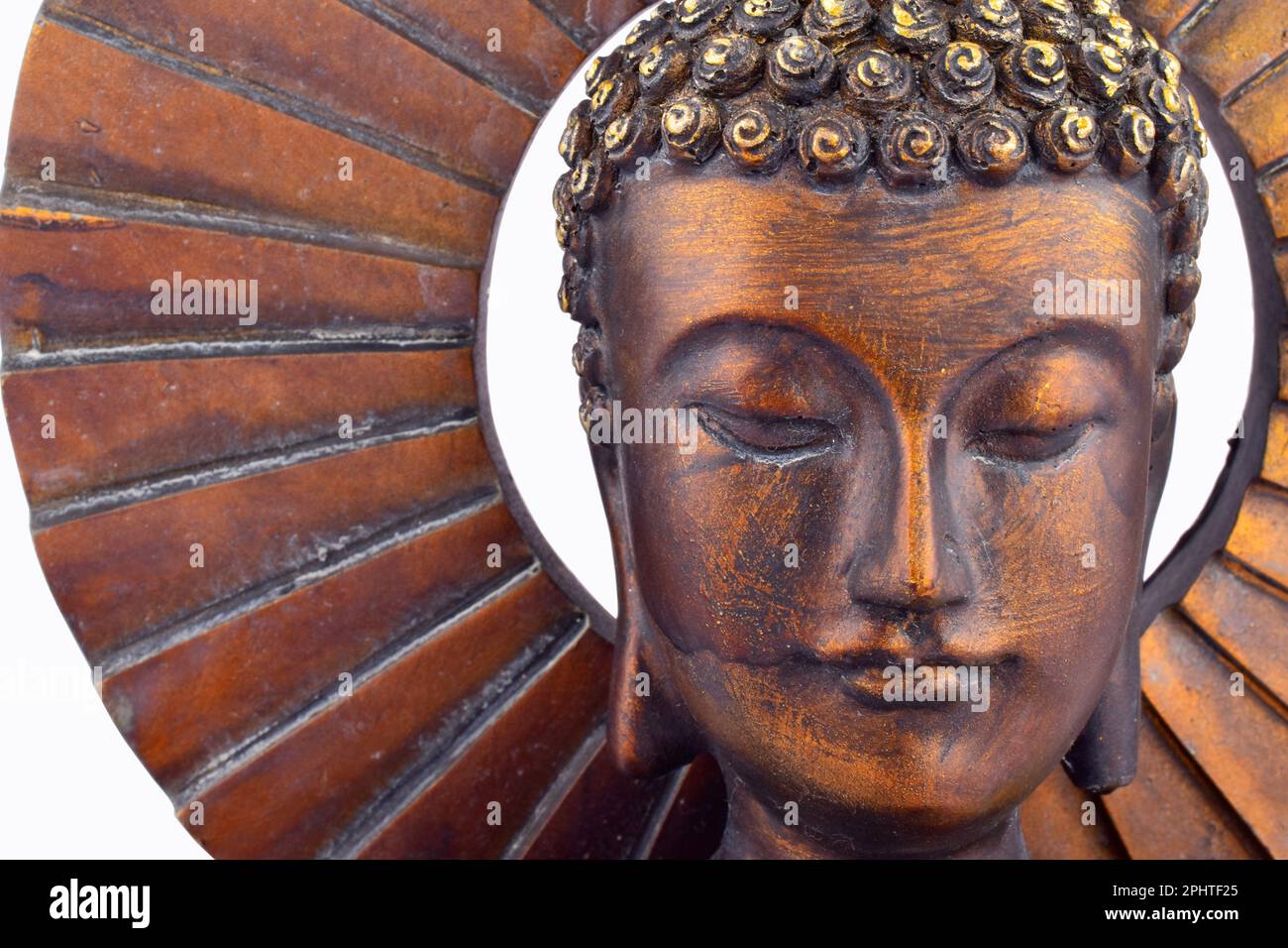 Closeup of copper made buddha face statue isolated on white background ...