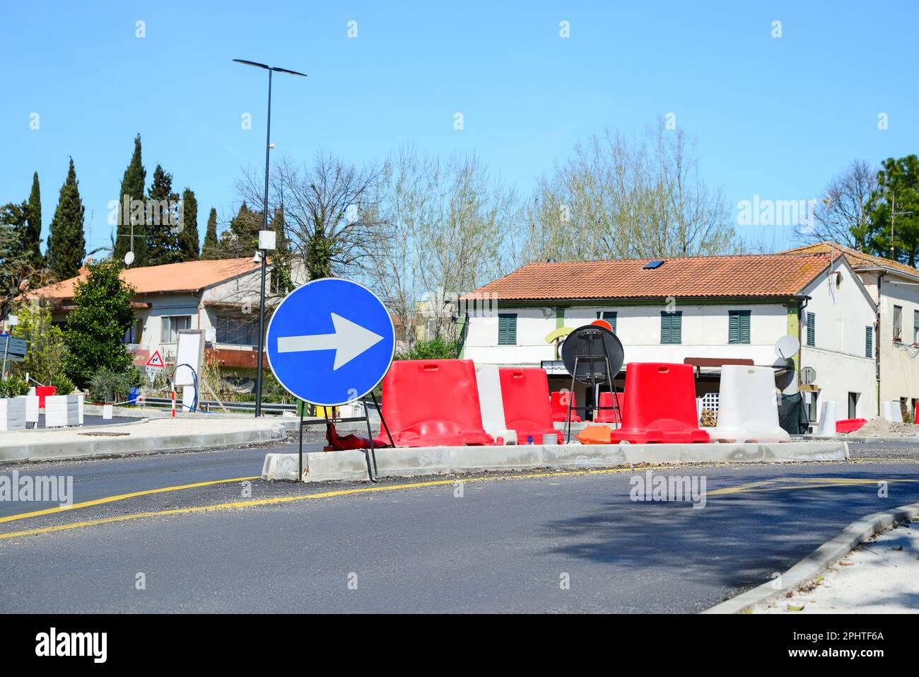 Street with road sign One Way Traffic, plastic safety barrier and ...