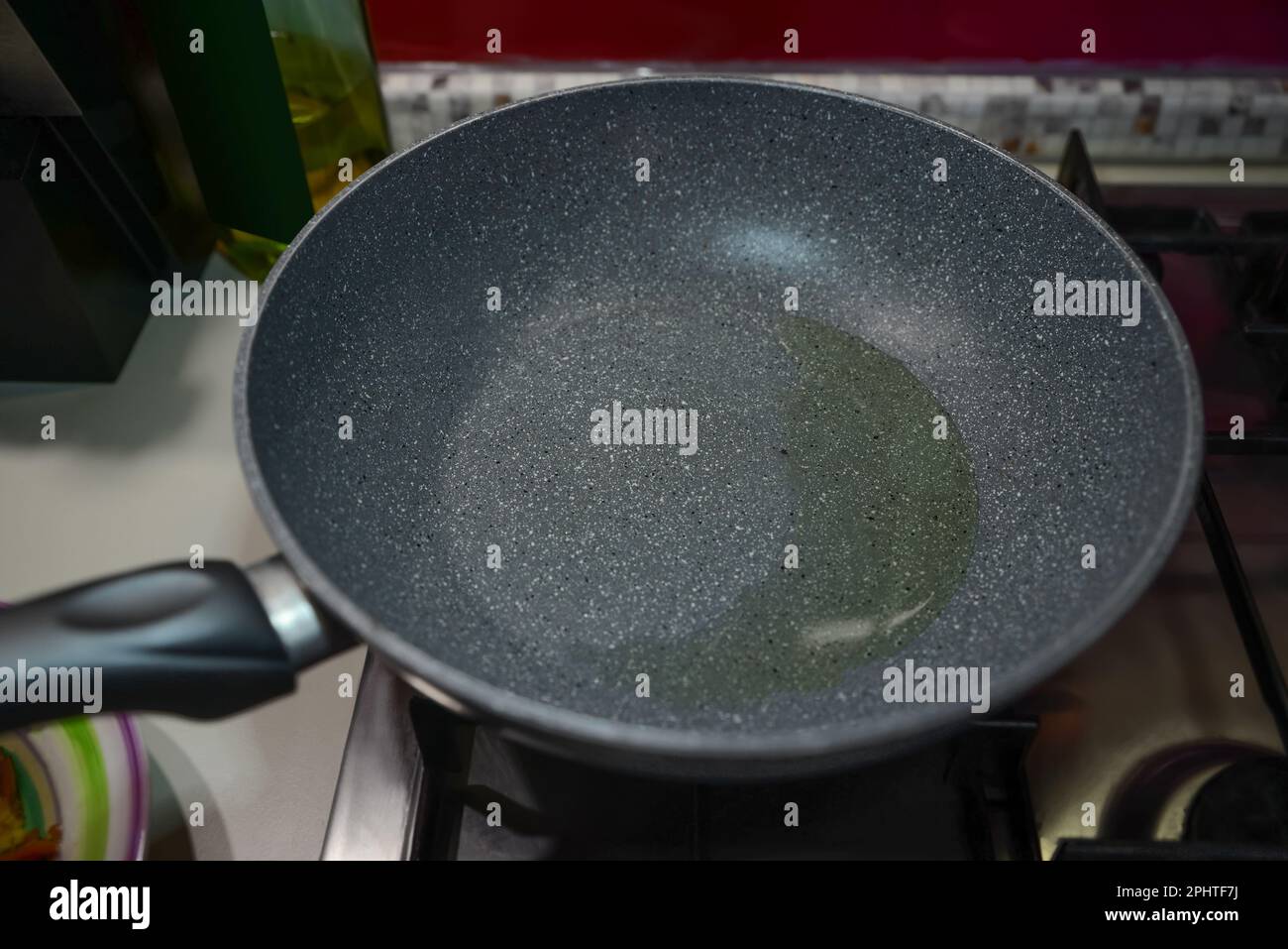 Frying pan with cooking oil on stove Stock Photo - Alamy