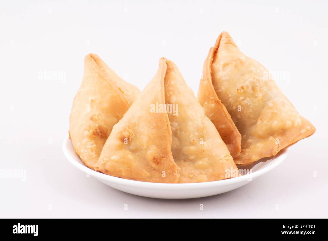 Samosa in plate isolated on white background Stock Photo - Alamy