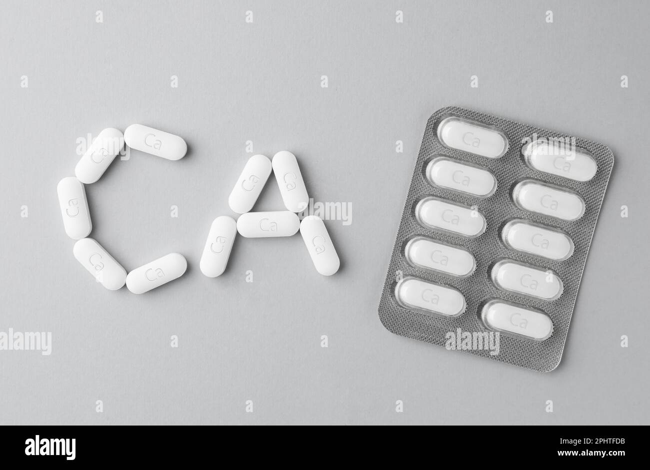 Blister pack with calcium supplement pills on light grey background ...