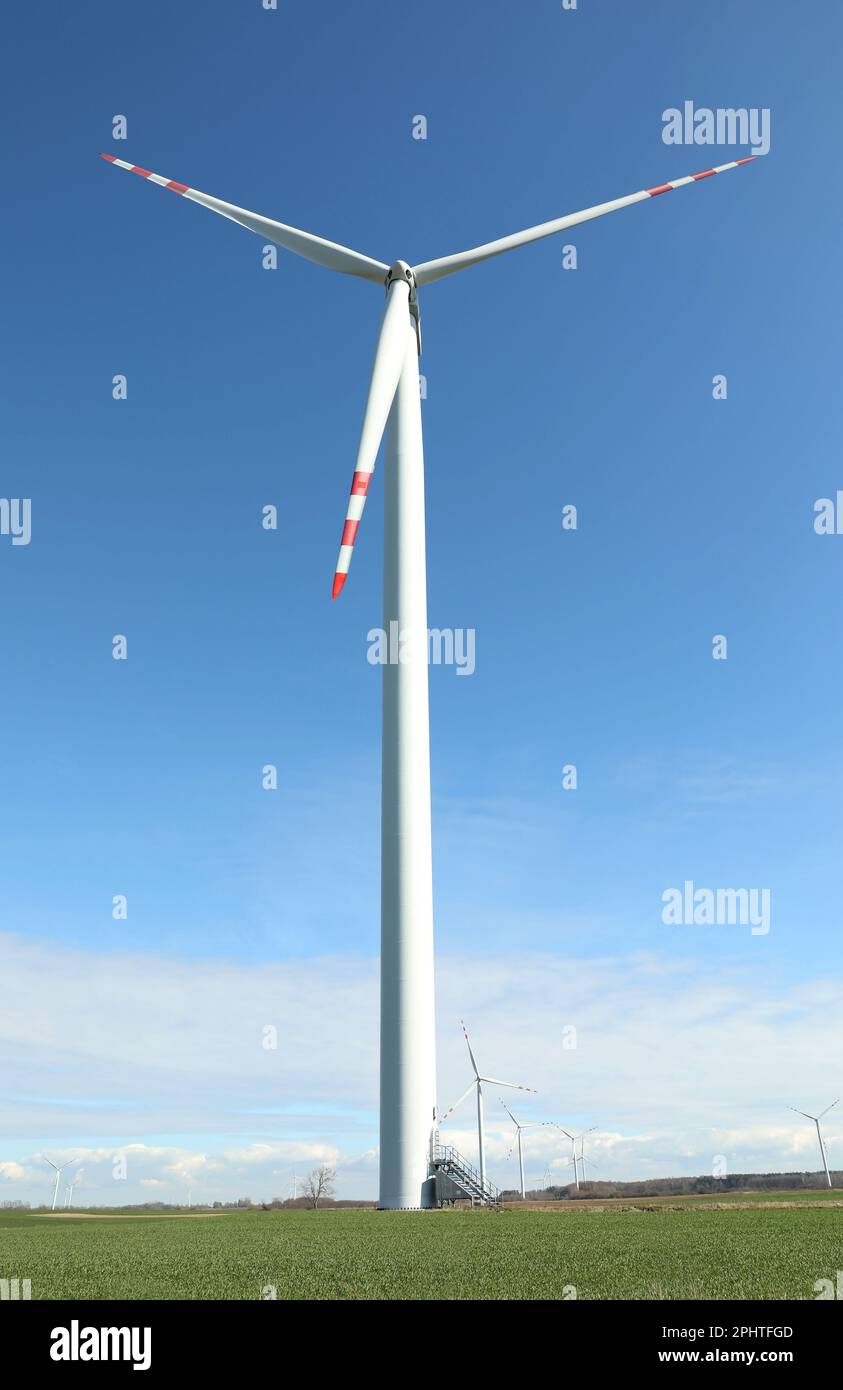 Modern wind turbine in field. Alternative energy source Stock Photo - Alamy