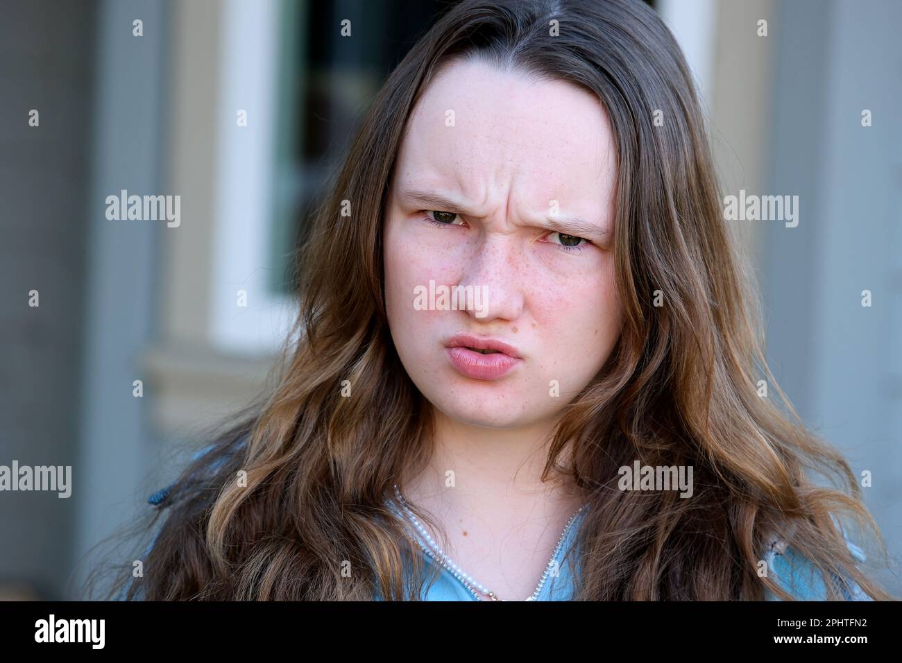 shot of dissatisfied girlfriend frowns face, raises eyebrows in ...
