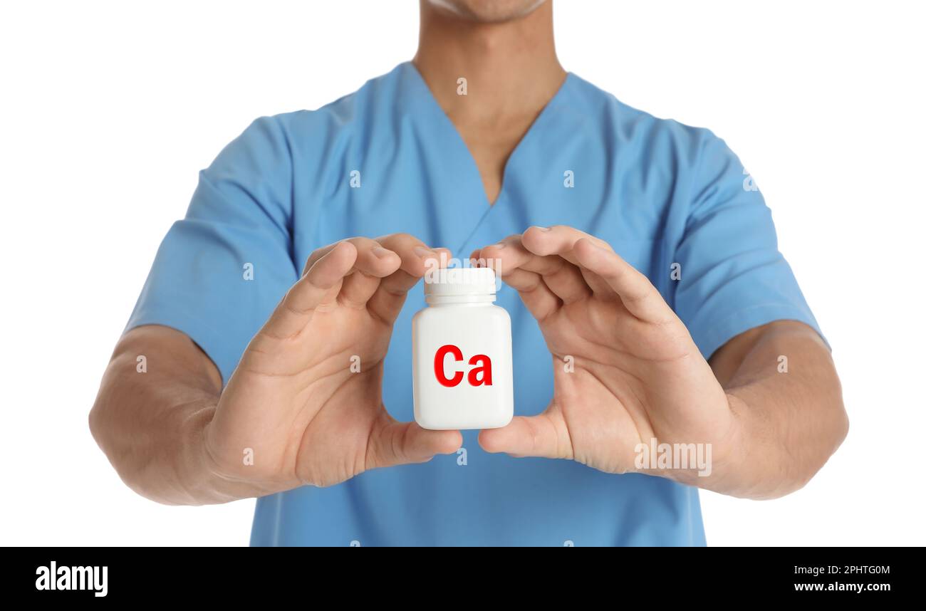 Calcium supplement. Doctor holding bottle with pills on white ...