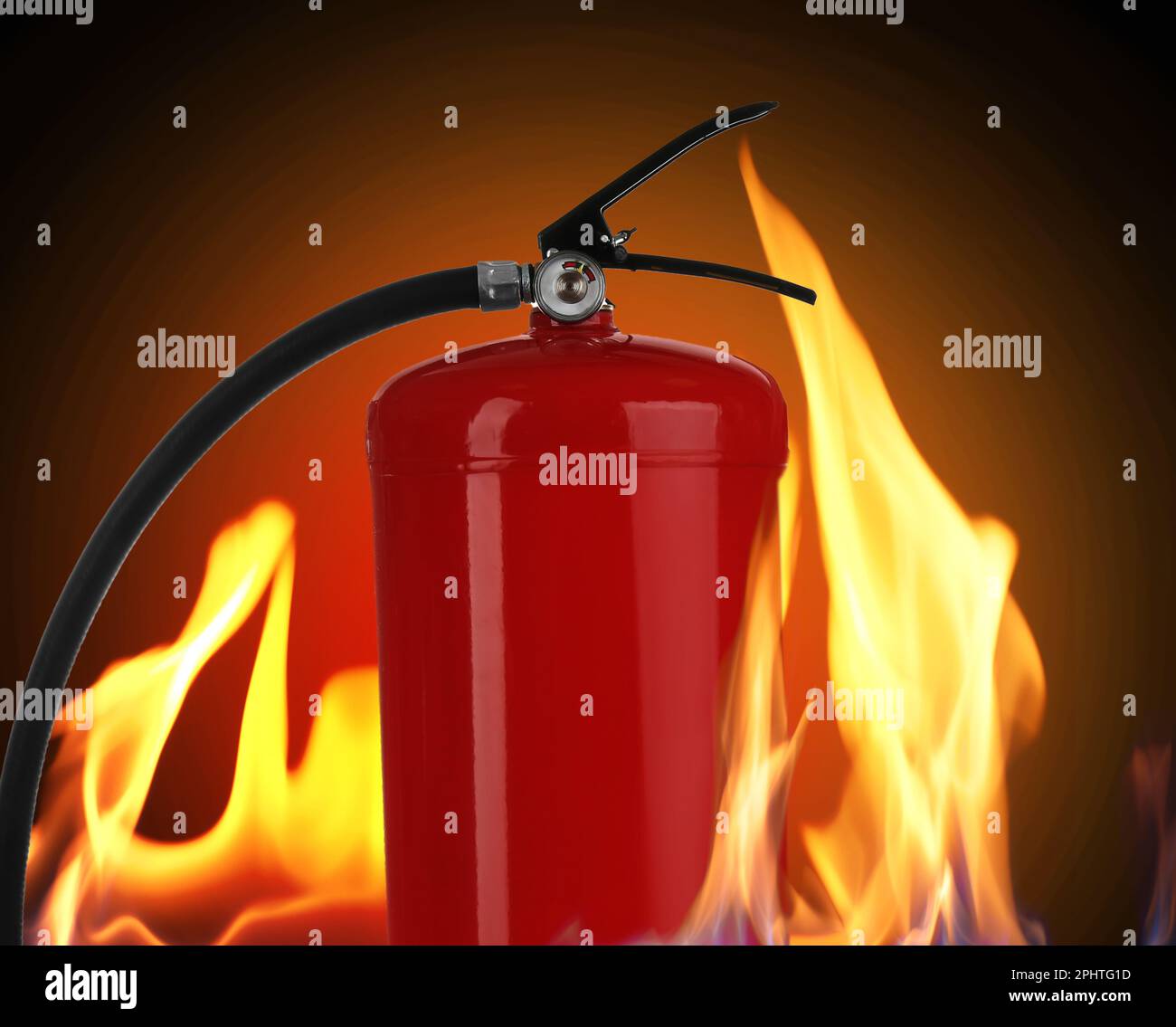 Fire extinguisher surrounded by flame on dark background Stock Photo ...