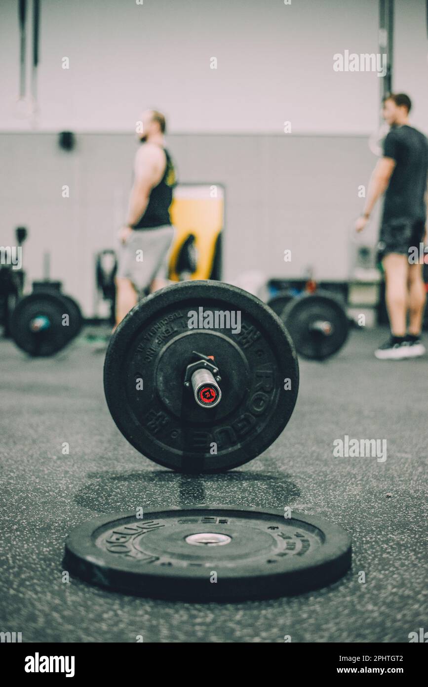 side view of barbell weight lifting exercise in a crossfit gym ...