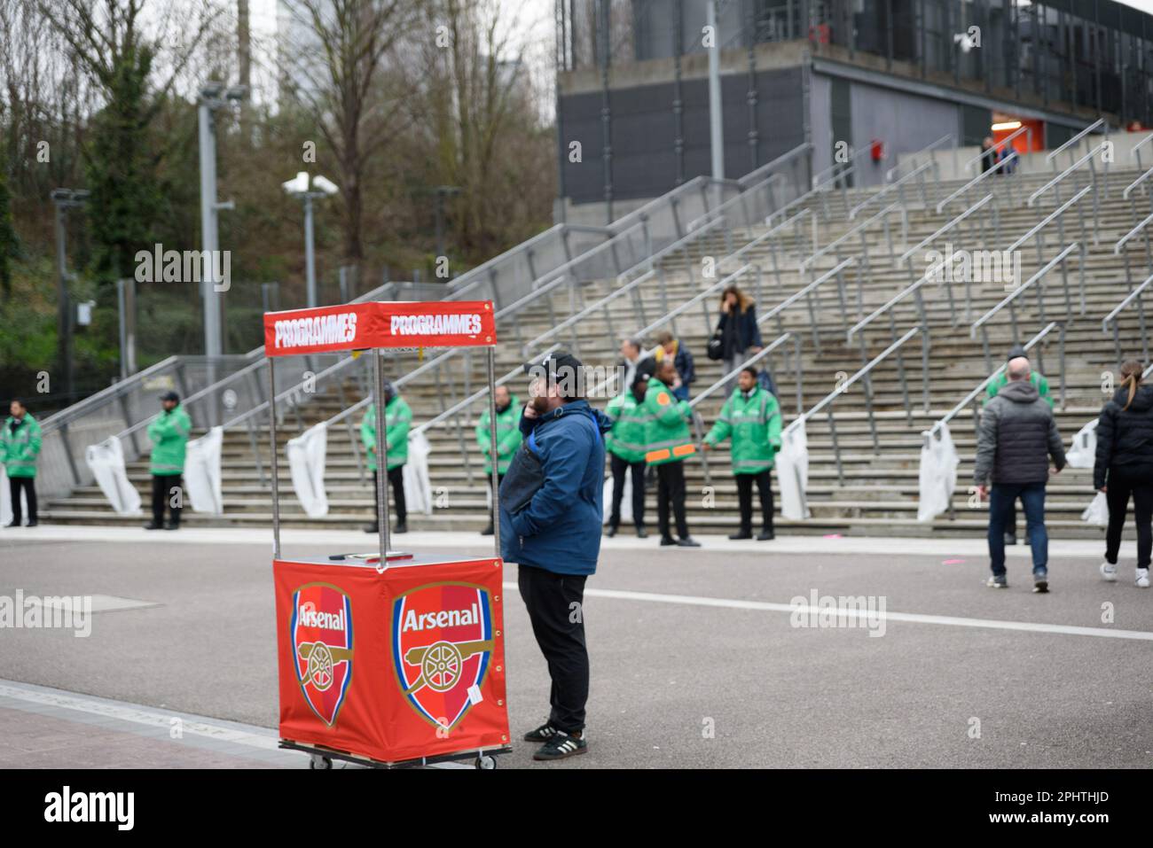 Match programme stall and seller in front of the Emirates Stadium ...
