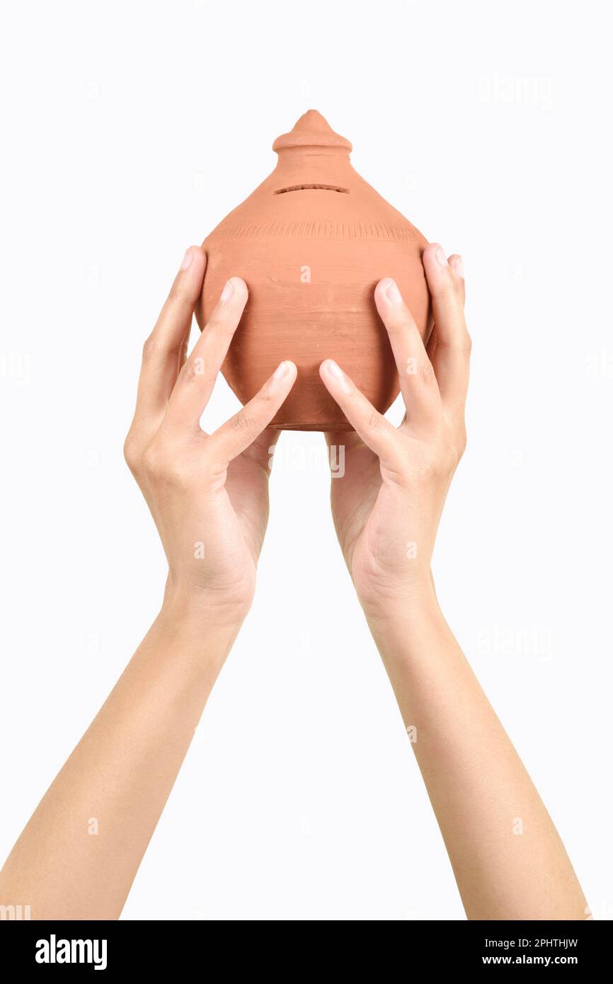 Gullak in hand isolated on white background with clipping path, saving ...