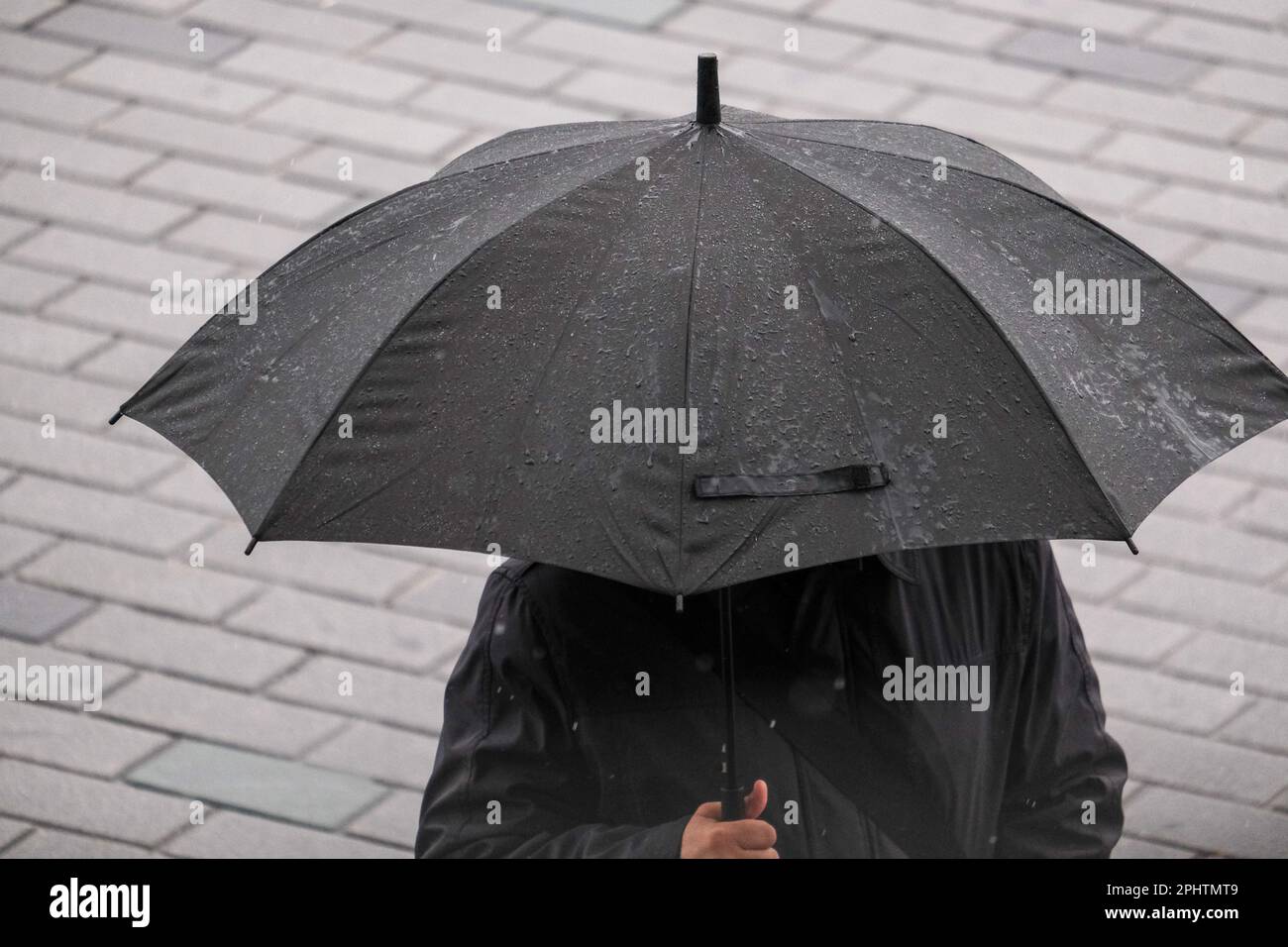 Close up man holding umbrella under rain walking with no showing face ...