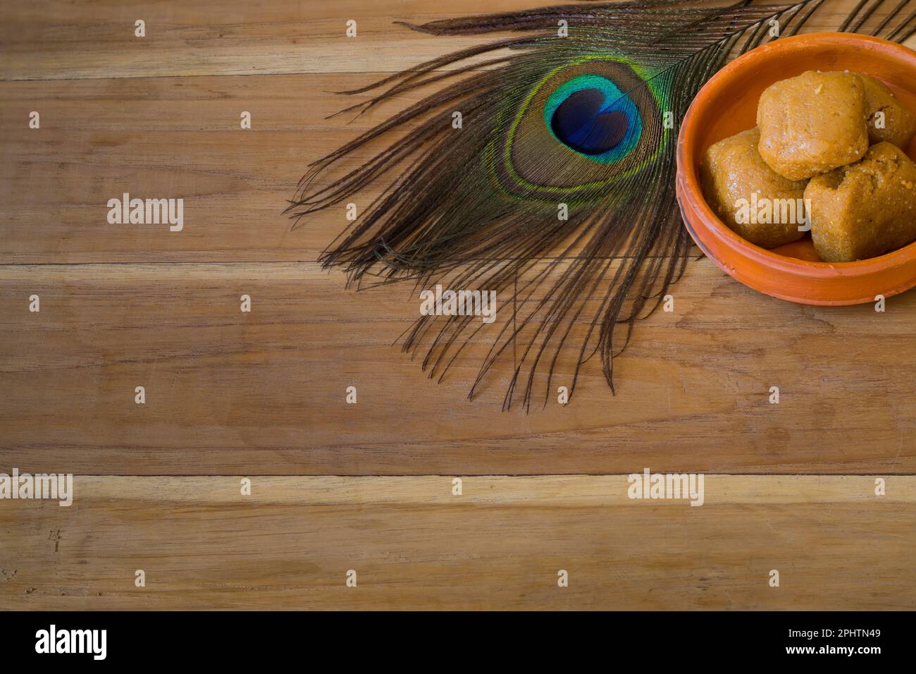 Mathura ka peda is served on a clay plate with peacock feather during ...